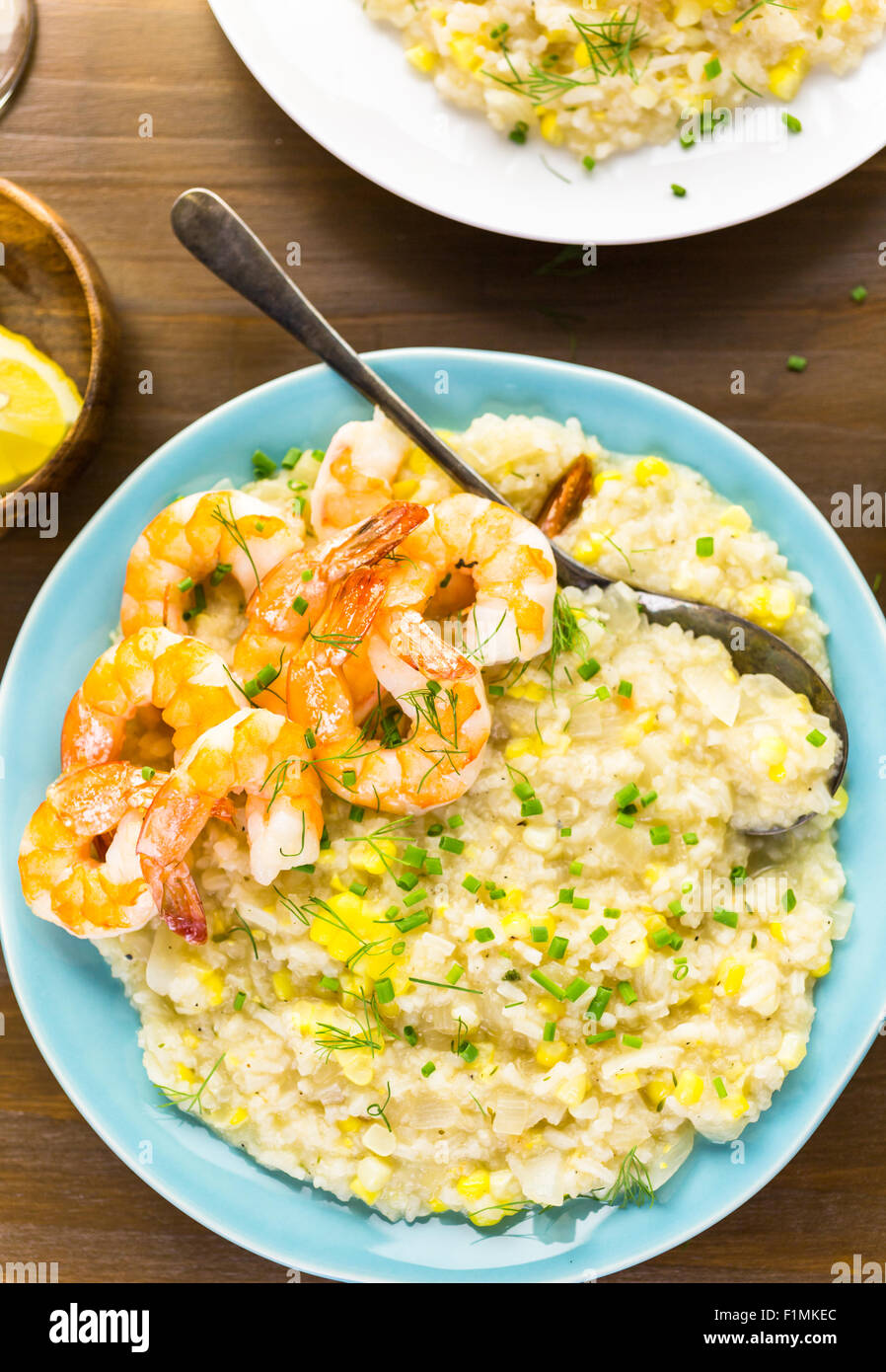 Homemade corn risotto with roasted shrimp on dining table Stock Photo ...