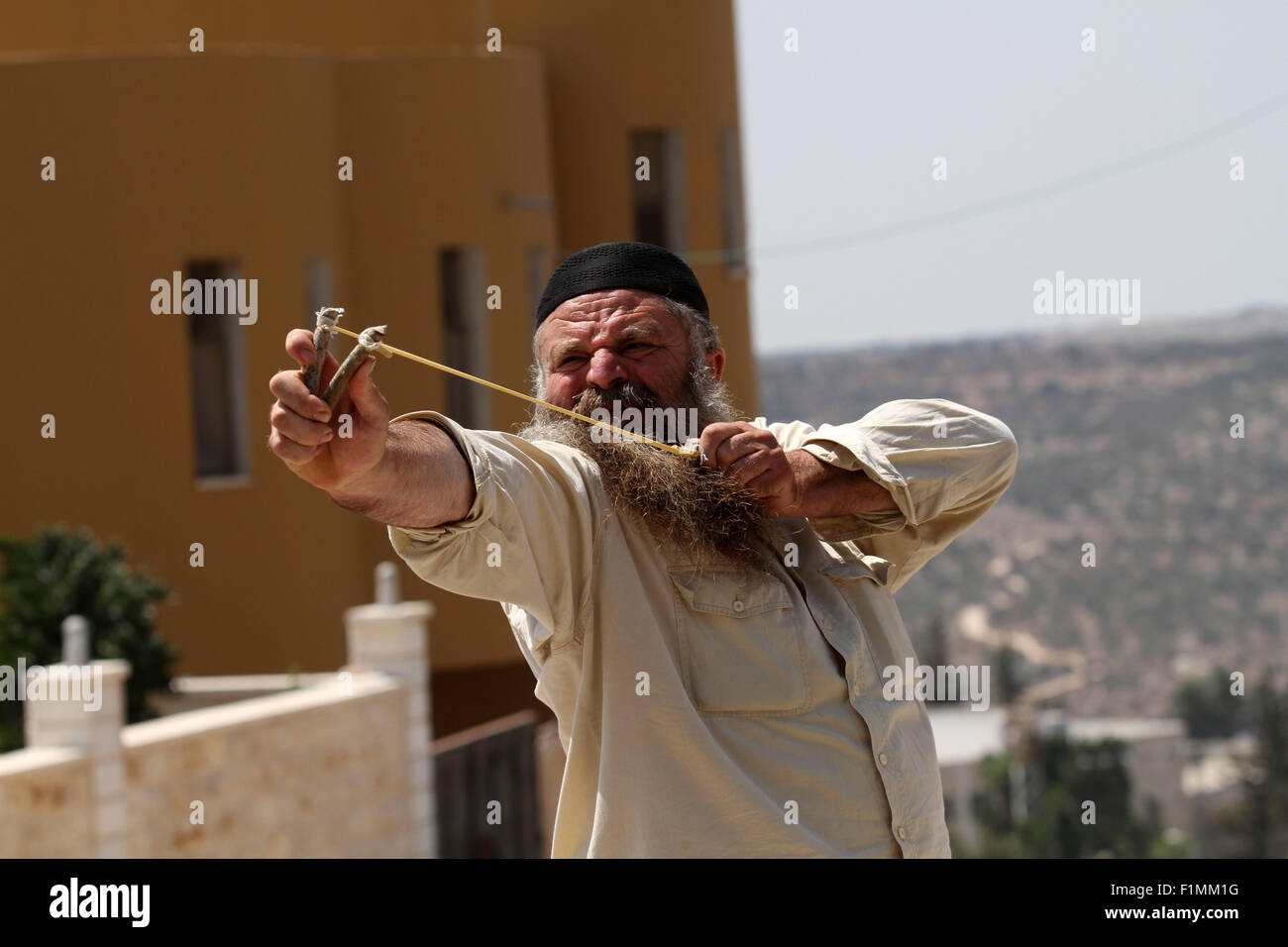 Palestinian man uses slingshot palestinian hi-res stock photography and ...