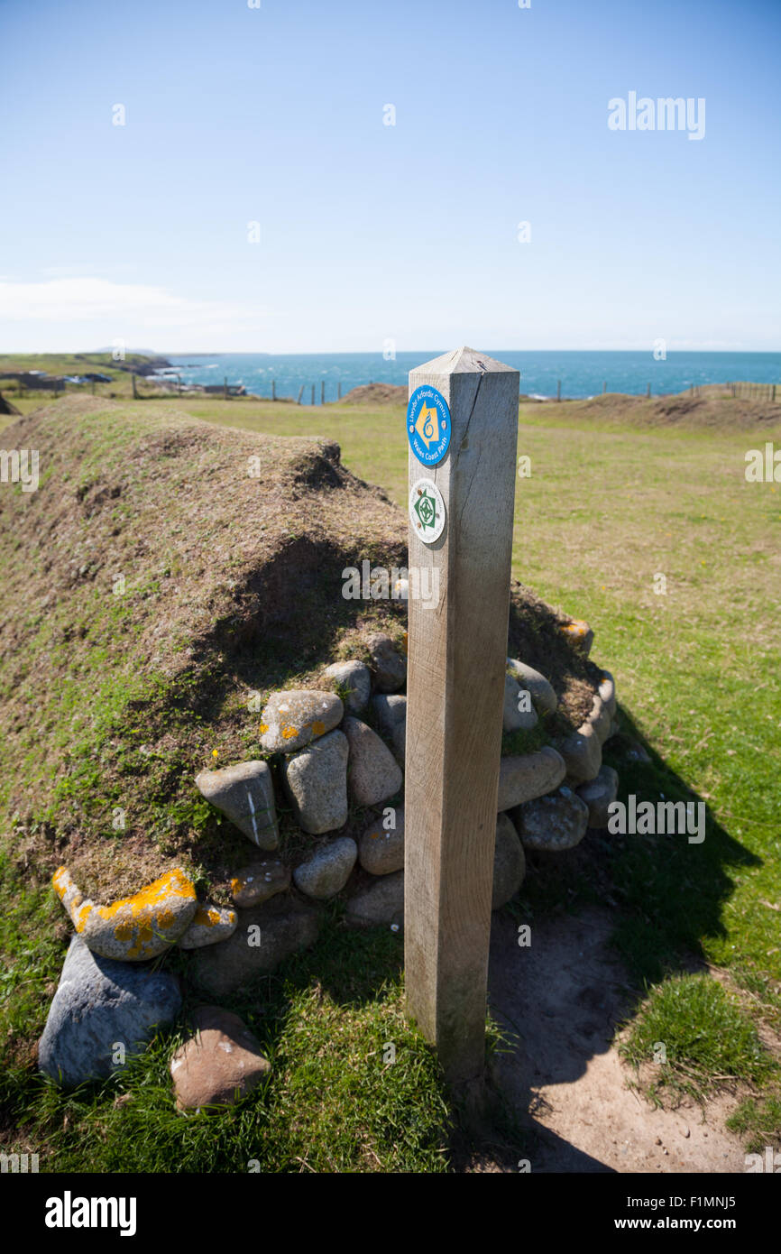 Wales coastal path / footpath marker waymarker with earth embankment at ...