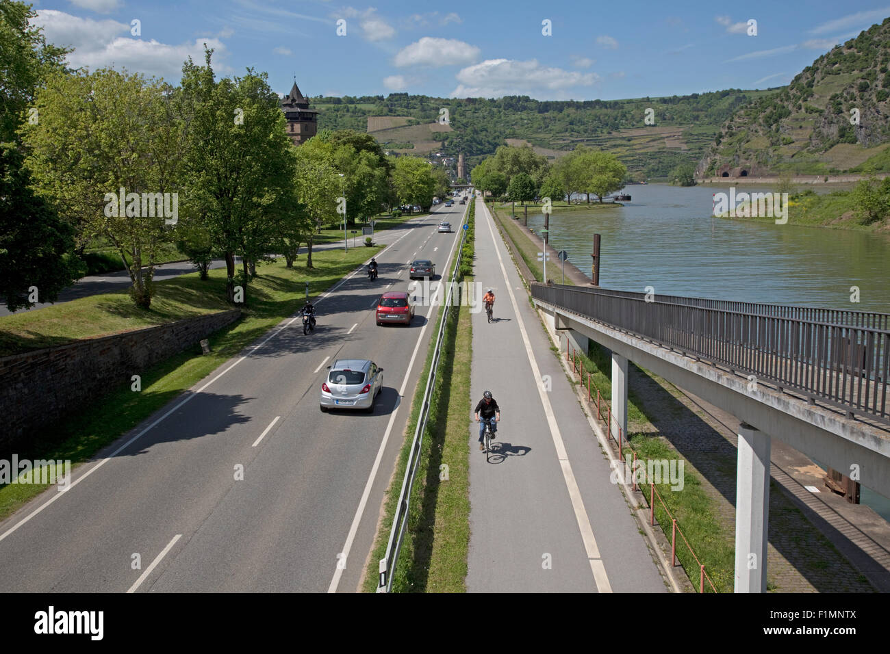Cyclists on cycle path alongside road and River Rhine Germany Stock ...