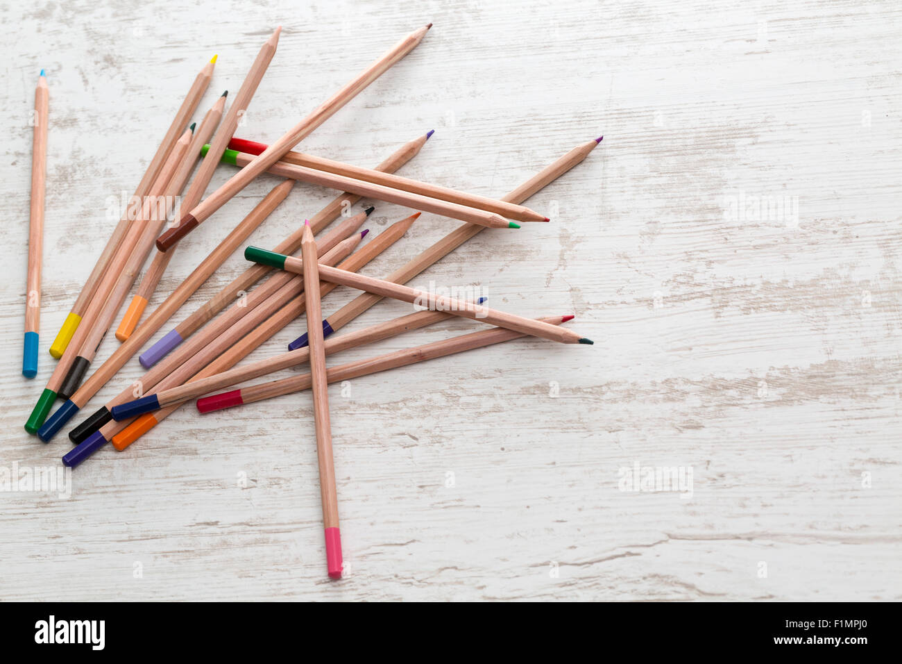 Upper view of a pile of colored pencils on a white wooden table Stock ...