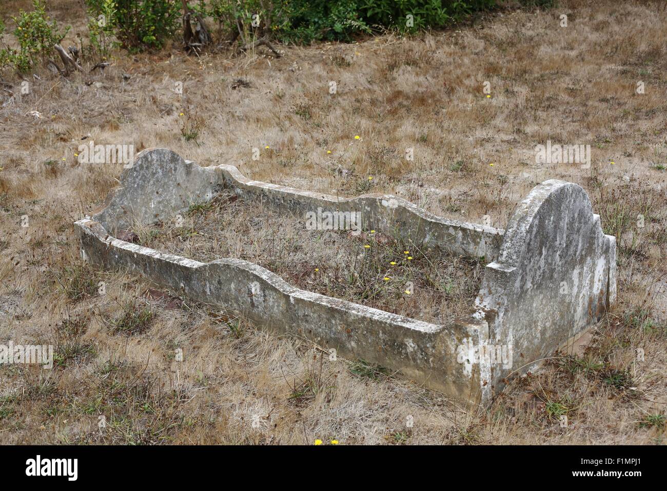 An old stone grave marker in a cemetery Stock Photo - Alamy