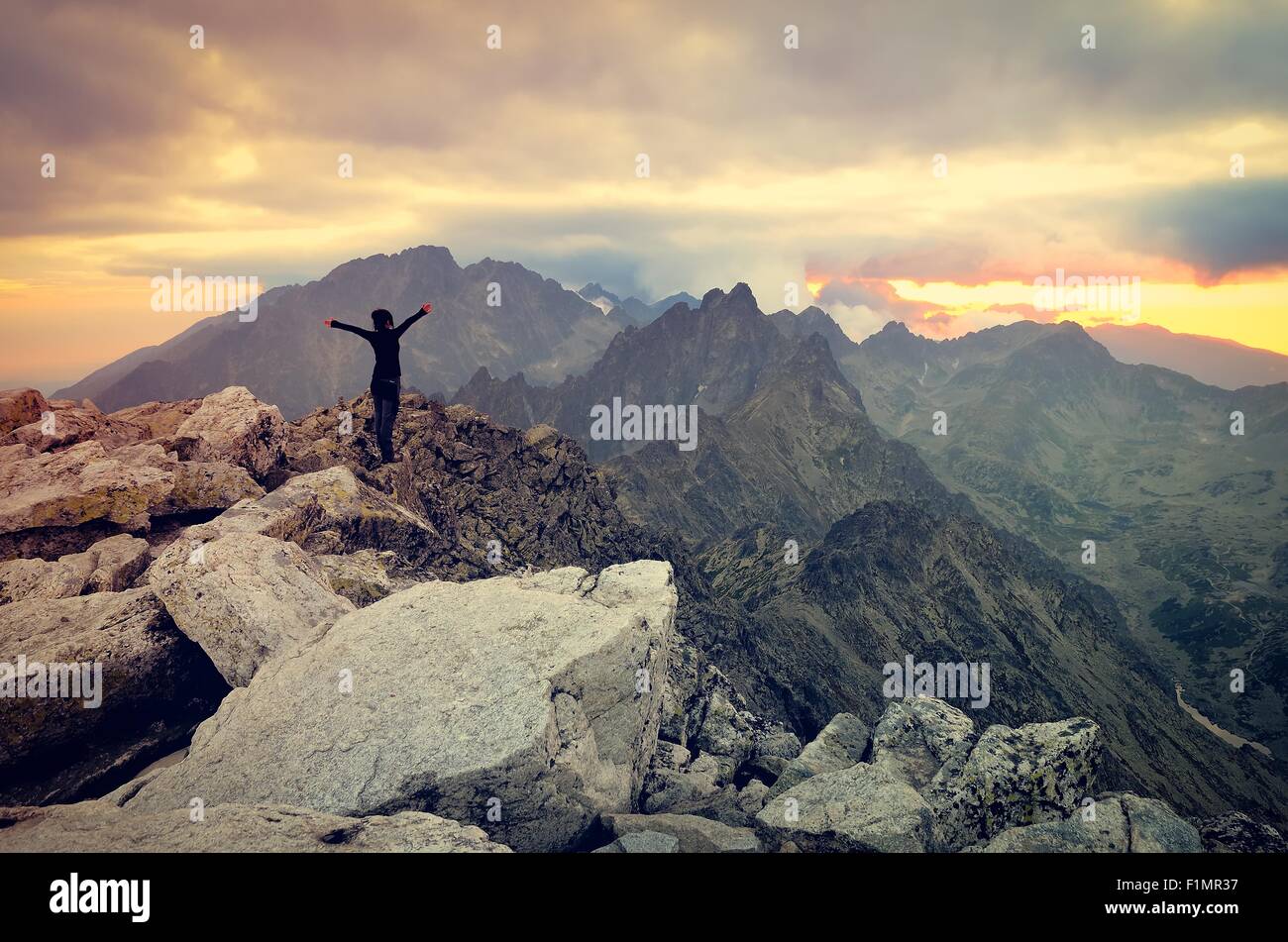 Mountain sunset landscape. A tourist in Slavkovsky Stit in High Tatra ...