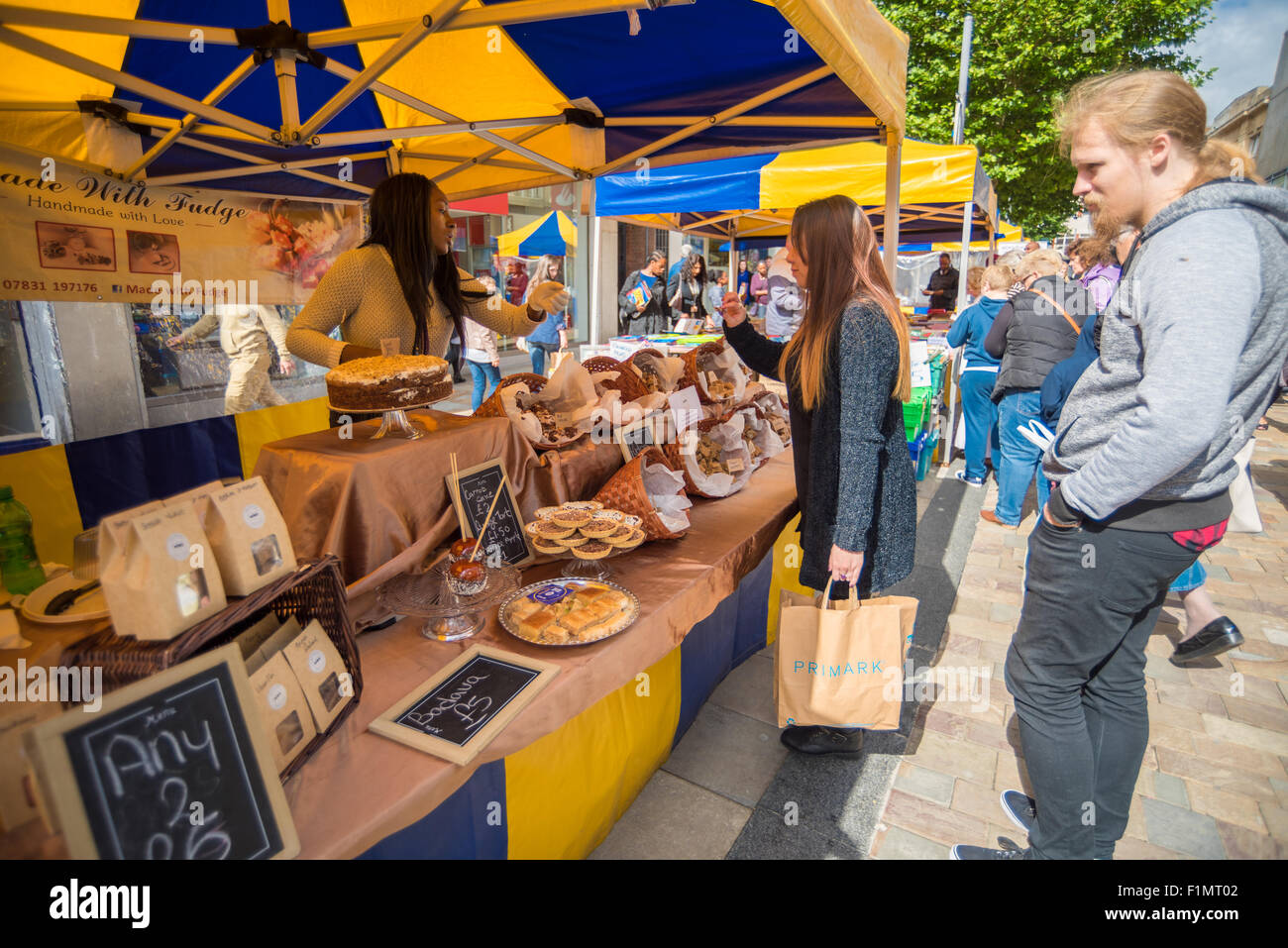 A lady serving on A Fudge and cake stall at Wolverhampton Street market ...