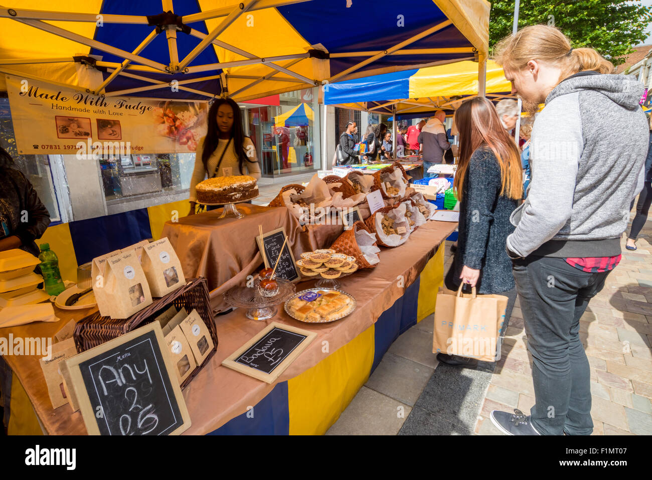 A lady serving on A Fudge and cake stall at Wolverhampton Street market ...