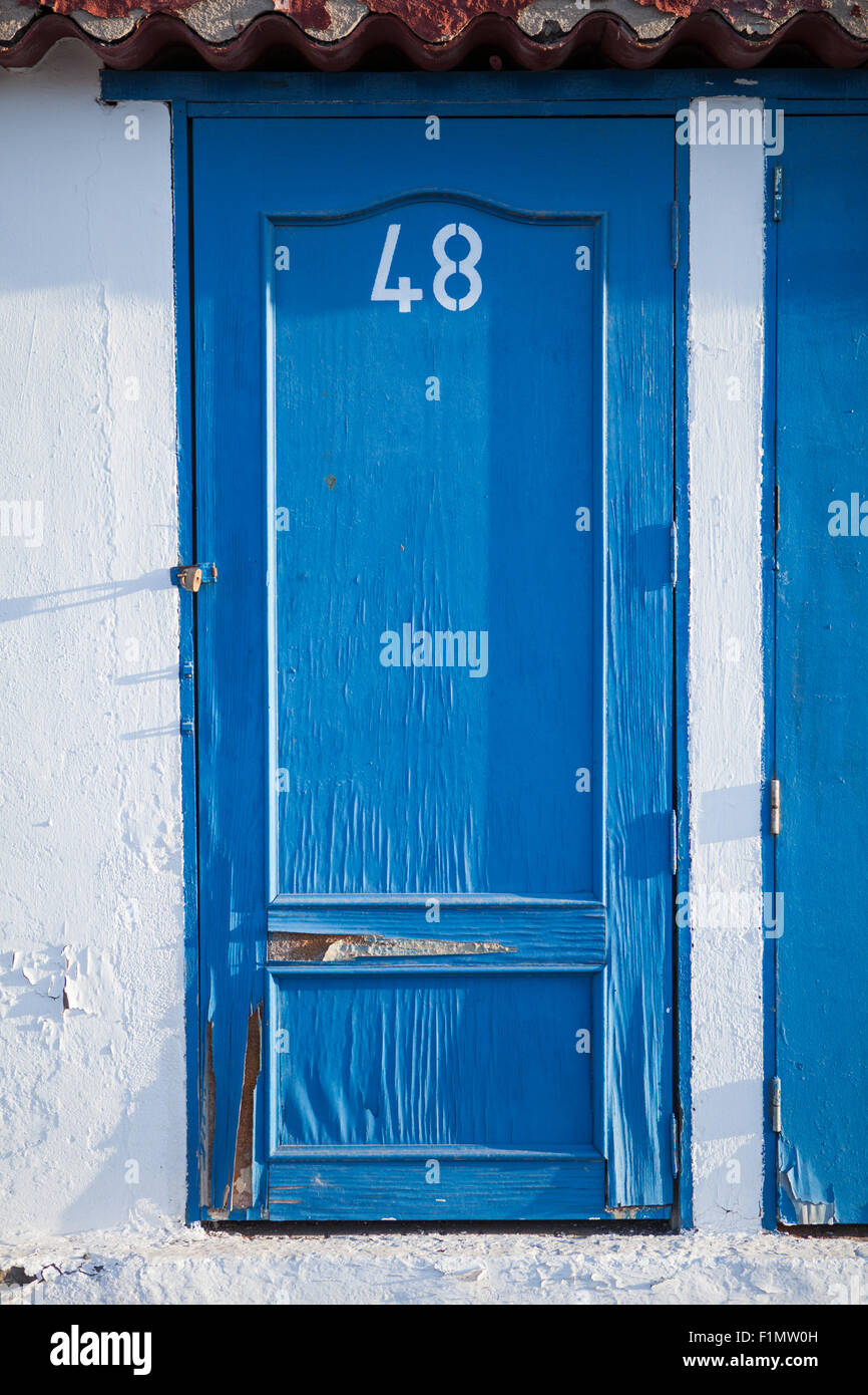 blue doors with number on white wall Stock Photo - Alamy