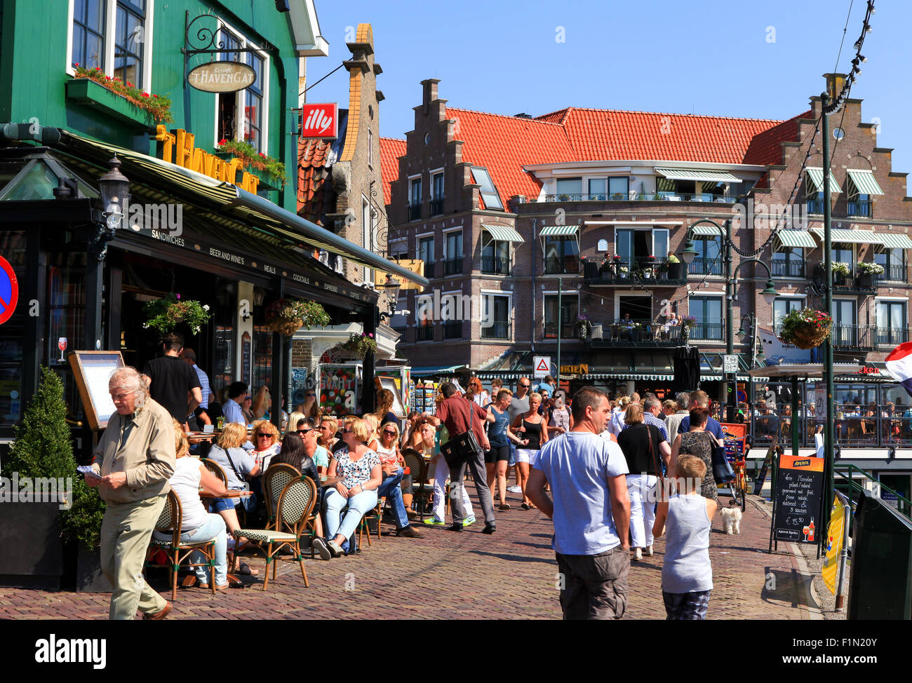 Tourists and locals at Volendam's boardwalk. Volendam is a famous Stock ...
