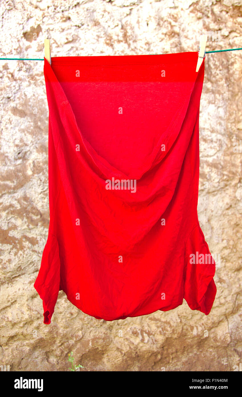 Single red t-shirt hanging on a clothesline Stock Photo - Alamy