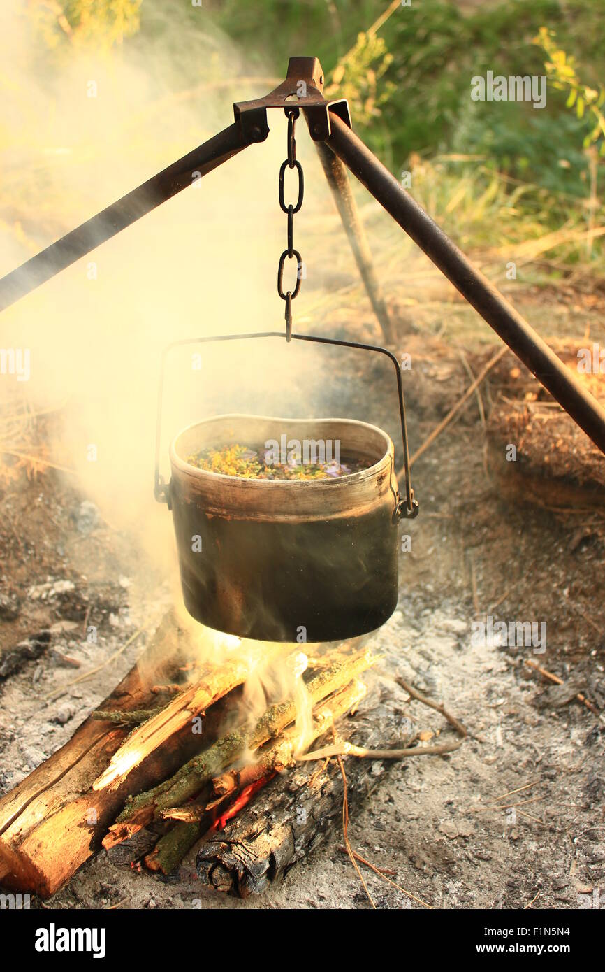 Cooking eat in bowler on the fire in a hike. Summer Stock Photo - Alamy