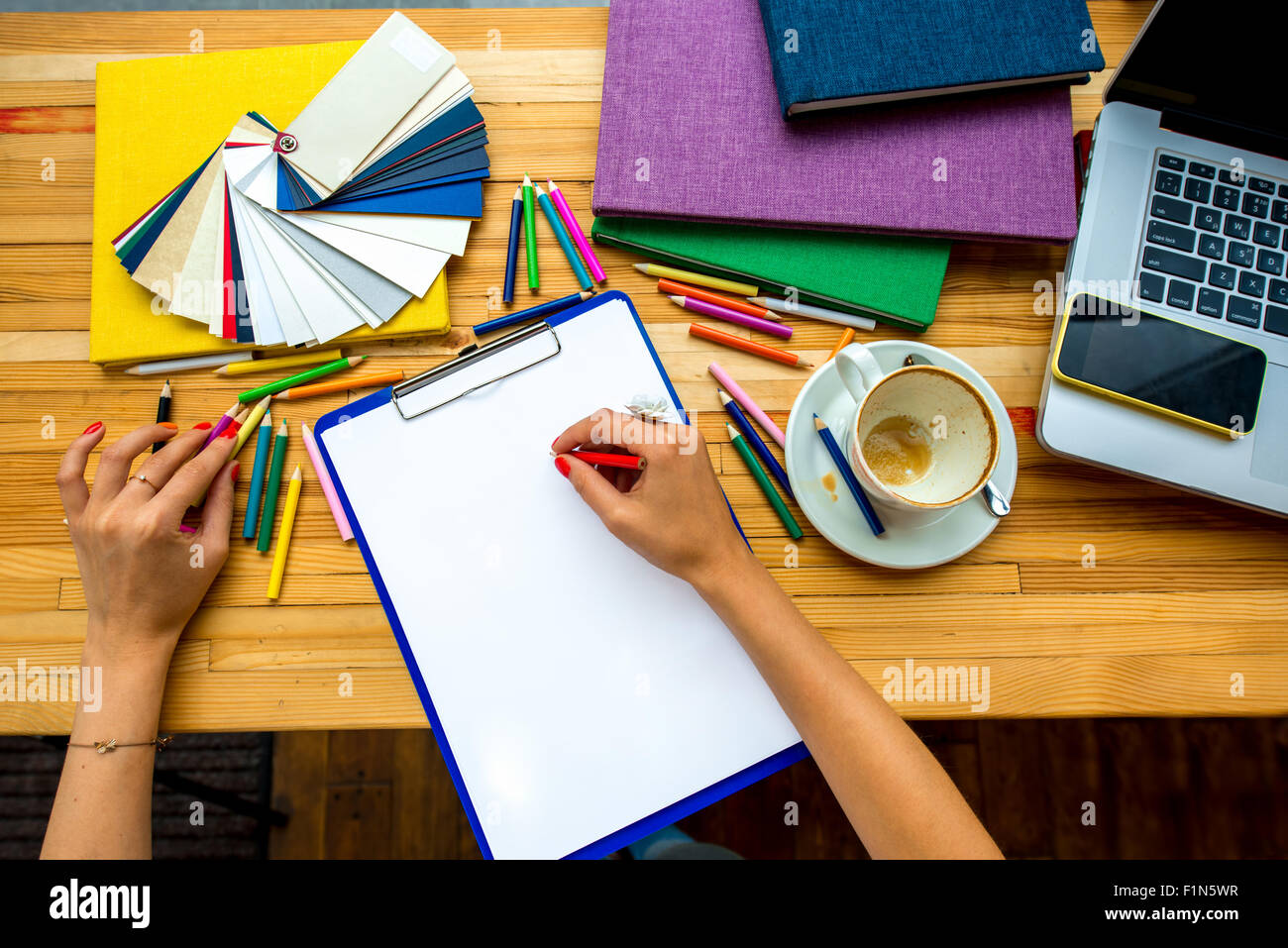 Writing with color pencil on the white sheet of paper Stock Photo - Alamy
