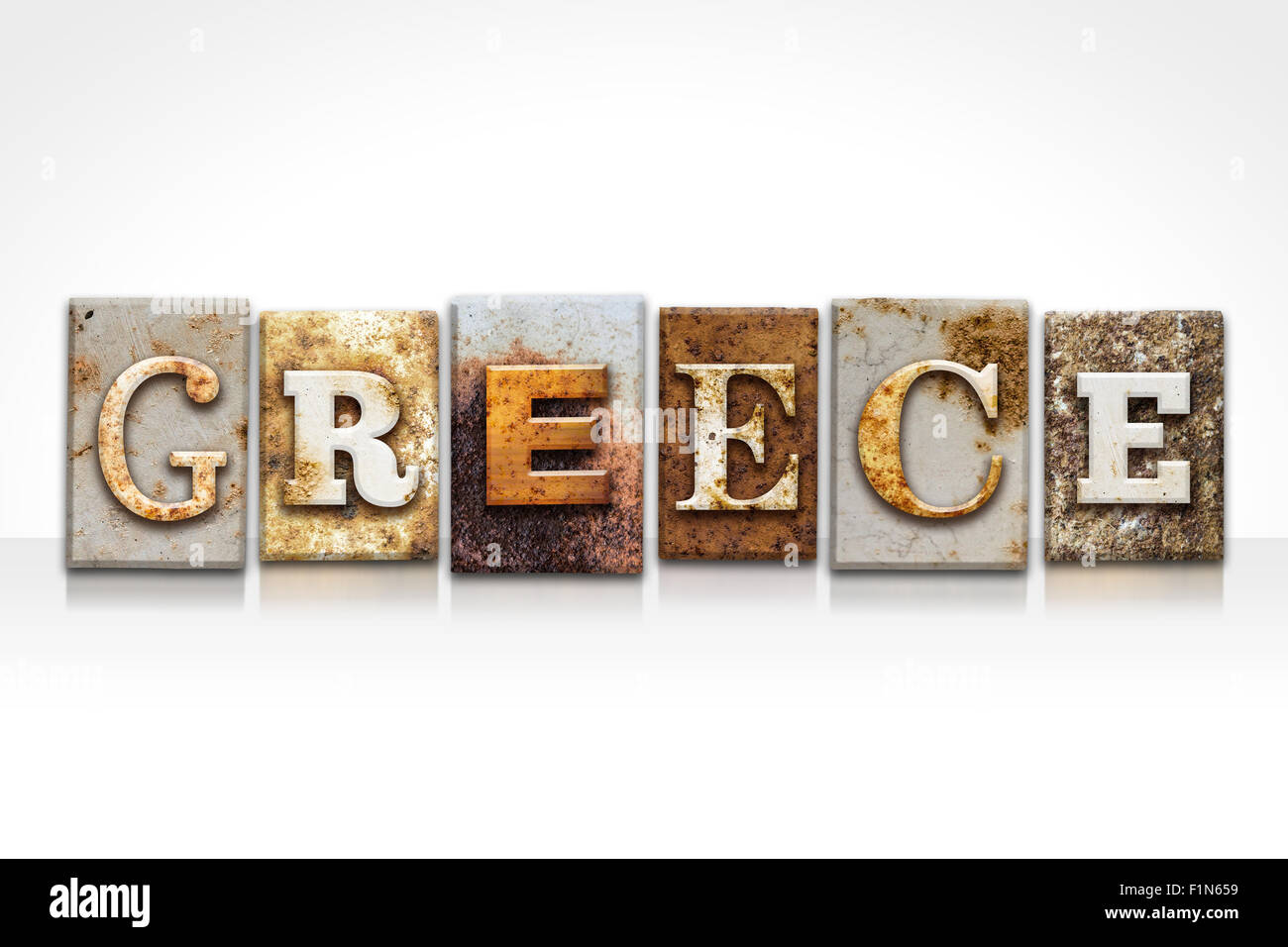 The word "GREECE" written in rusty metal letterpress type isolated on a ...