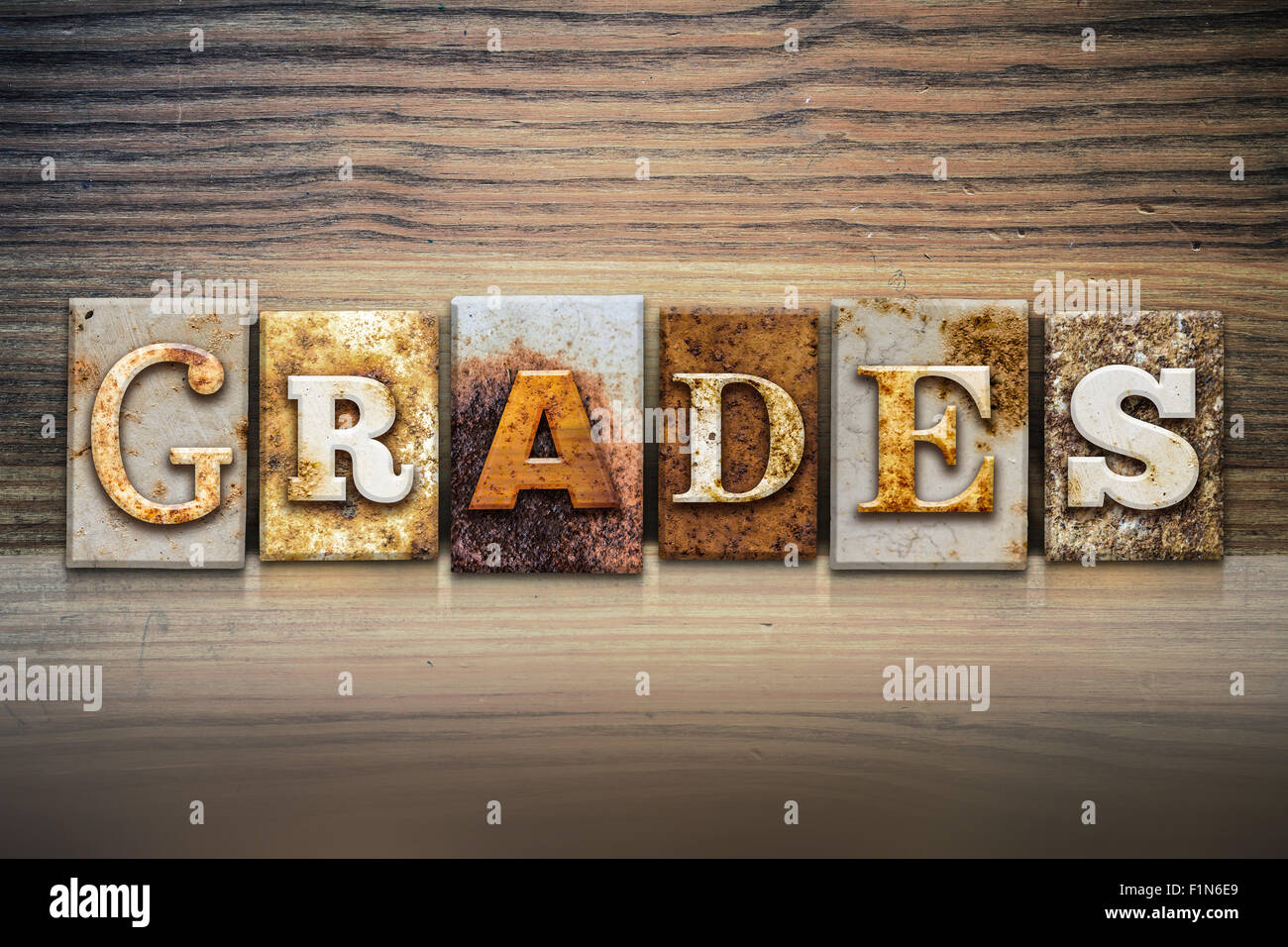The word "GRADES" written in rusty metal letterpress type sitting on a ...