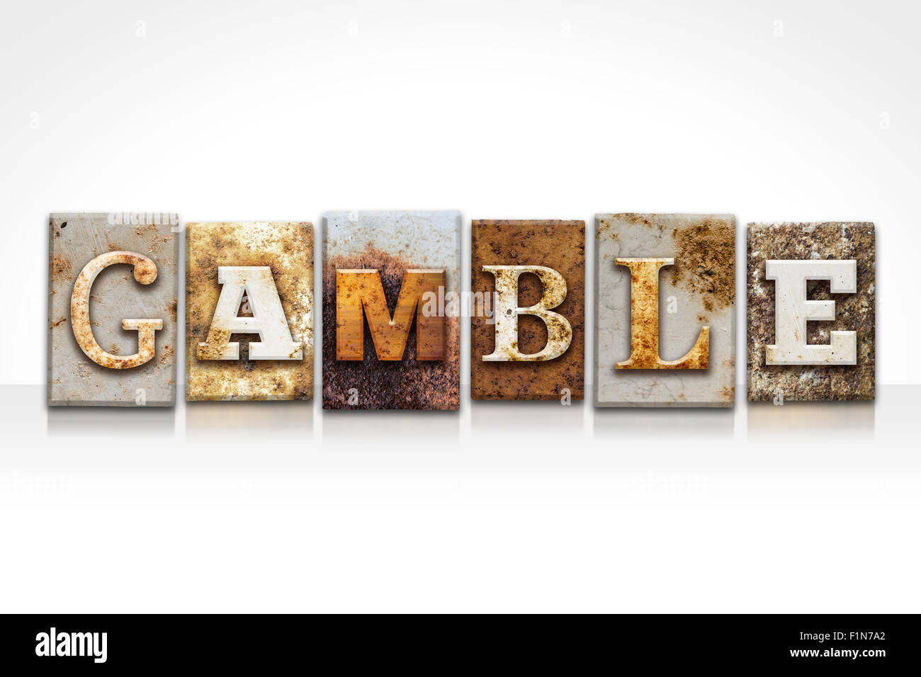 The word "GAMBLE" written in rusty metal letterpress type isolated on a ...
