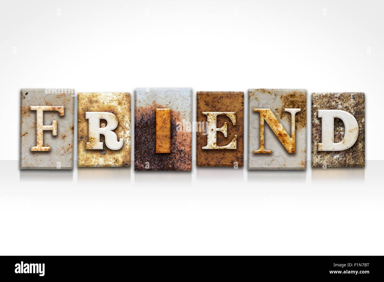 The word "FRIEND" written in rusty metal letterpress type isolated on a ...