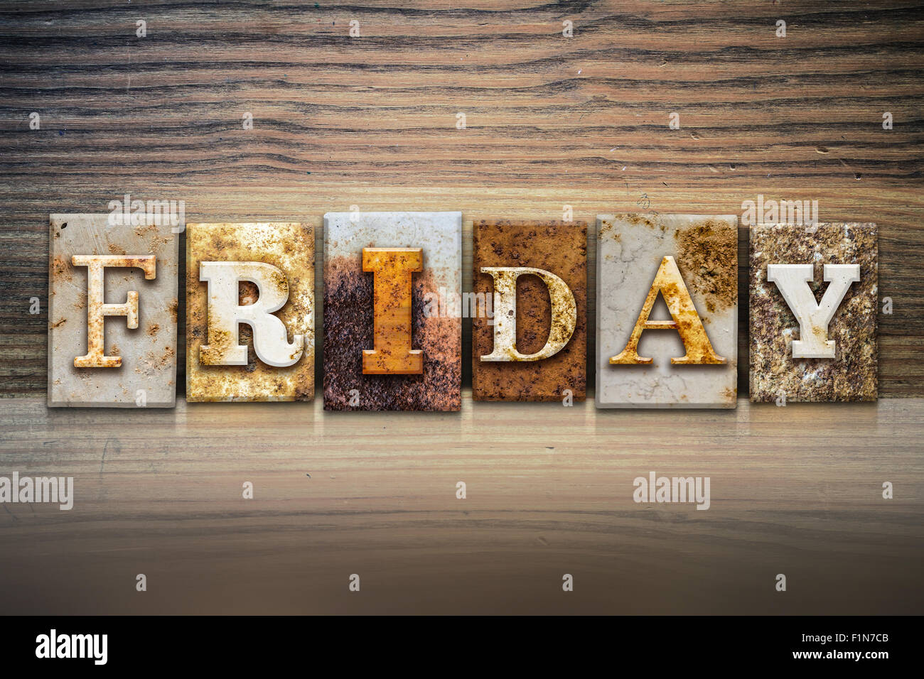 The word "FRIDAY" written in rusty metal letterpress type sitting on a ...