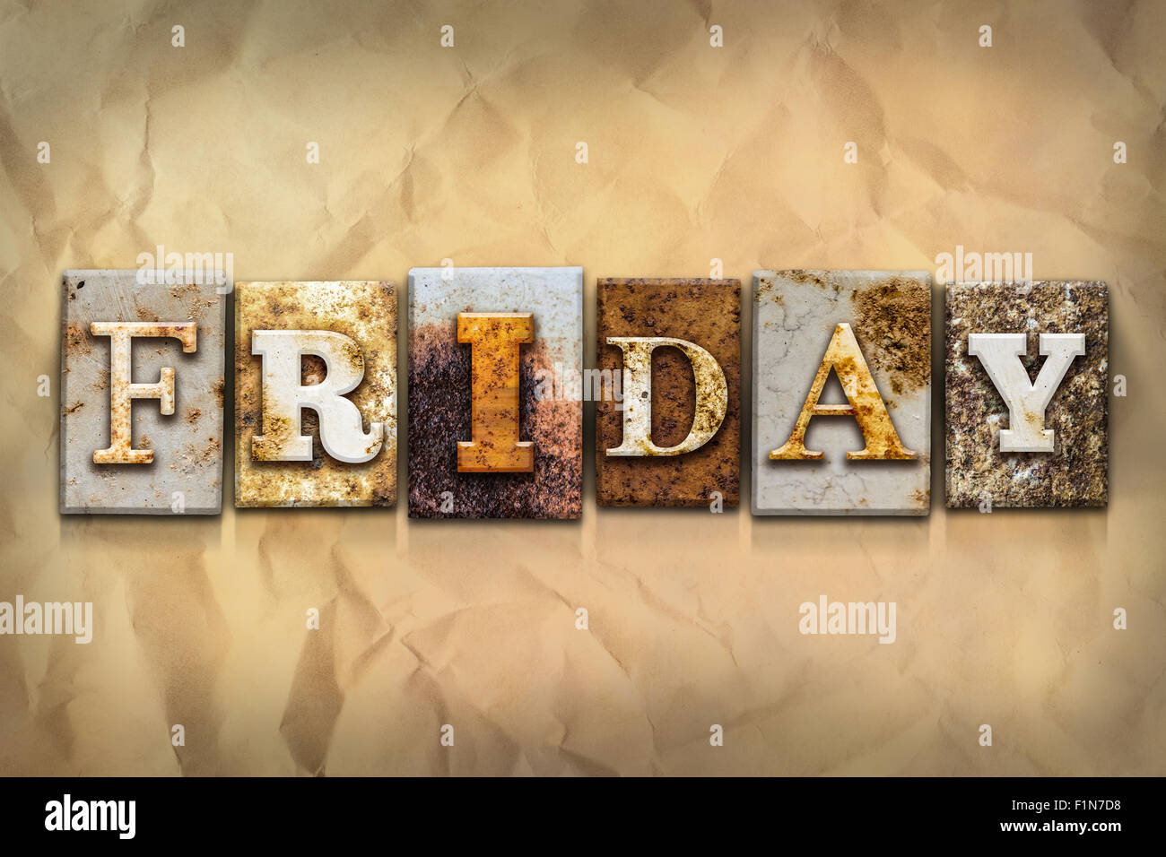 The word "FRIDAY" written in rusty metal letterpress type on a crumbled ...