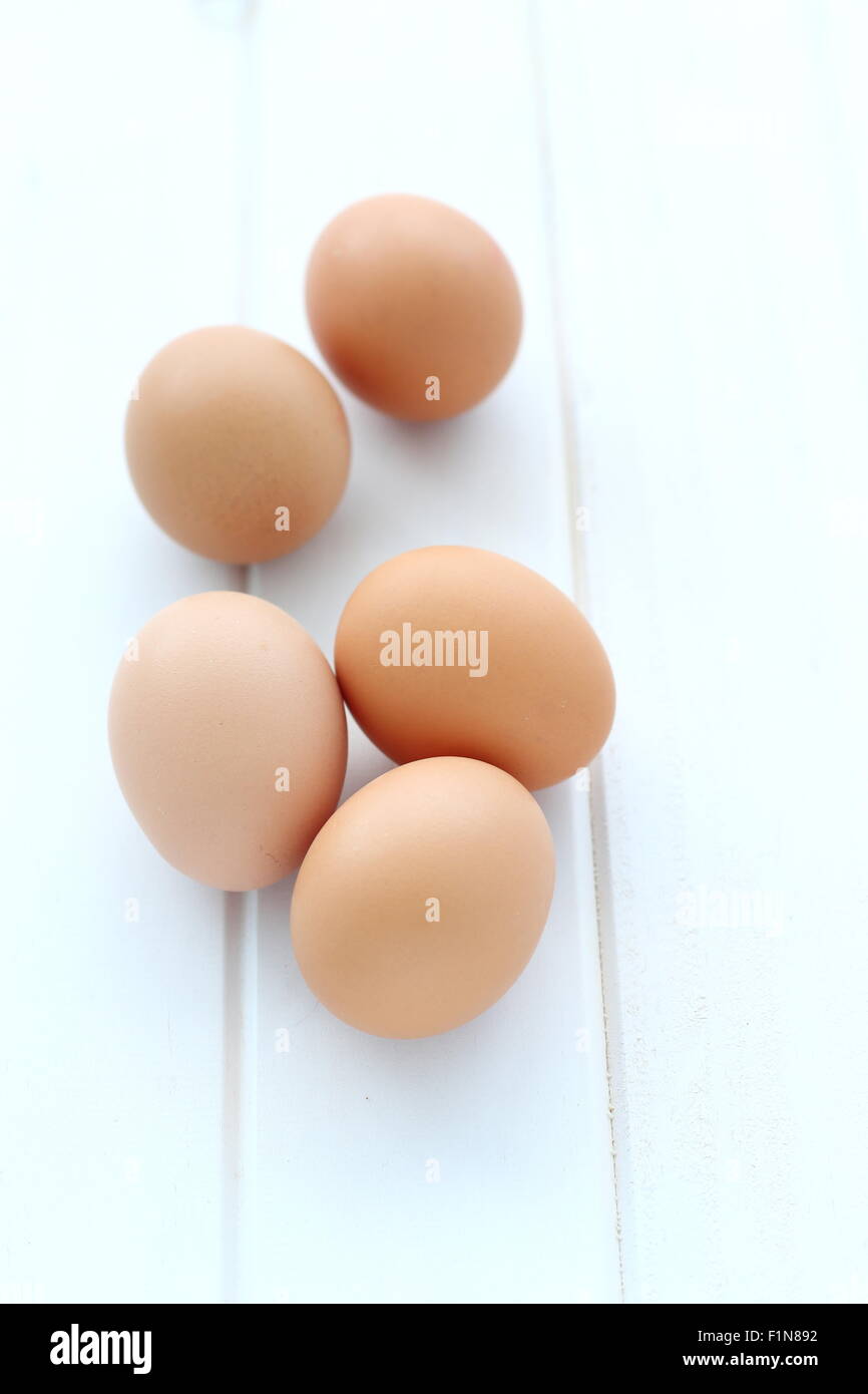 Five Eggs on white wooden board Stock Photo - Alamy
