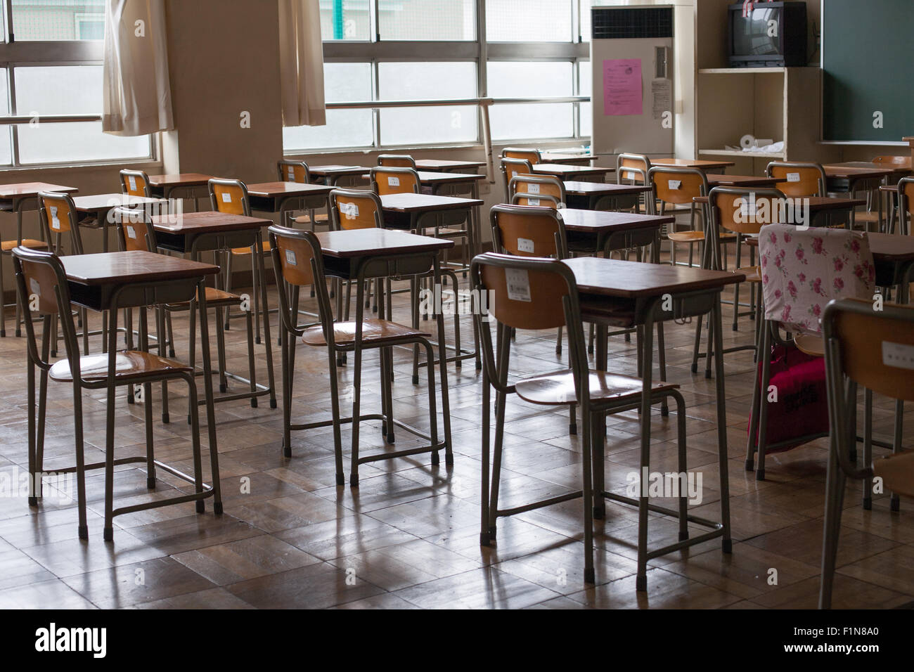 Empty classroom with wooden floors, desks and chairs landscape Stock ...