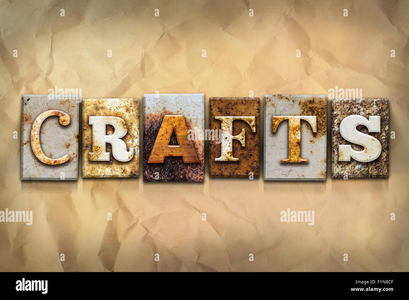 The word "CRAFTS" written in rusty metal letterpress type on a crumbled ...