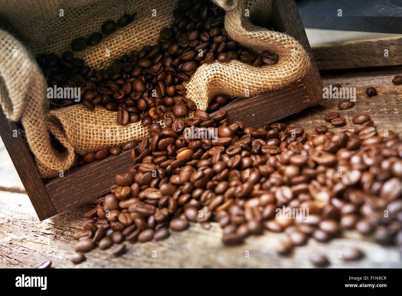 Spilled Coffee Beans on the Old Wood Table Stock Photo - Alamy