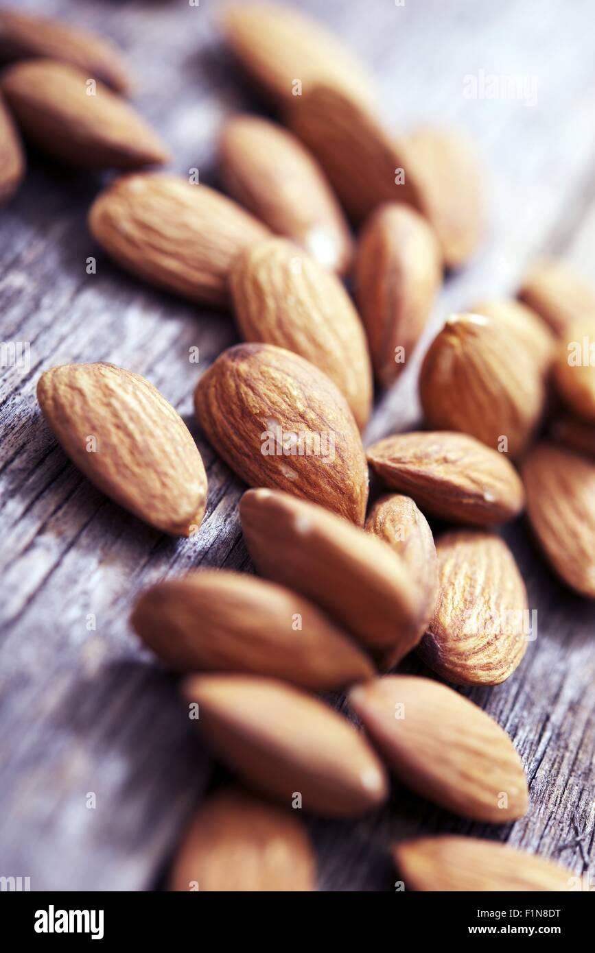 Tasty Almonds Nuts on Wood Table Closeup Stock Photo - Alamy