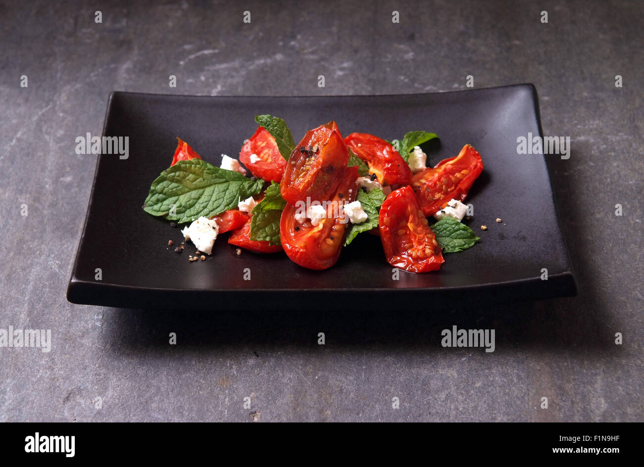 Semi-dried tomatoes with feta cheese & rocket Stock Photo - Alamy