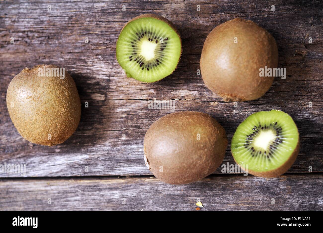 Kiwi on Aged Wood Table. Sliced Kiwi Stock Photo - Alamy