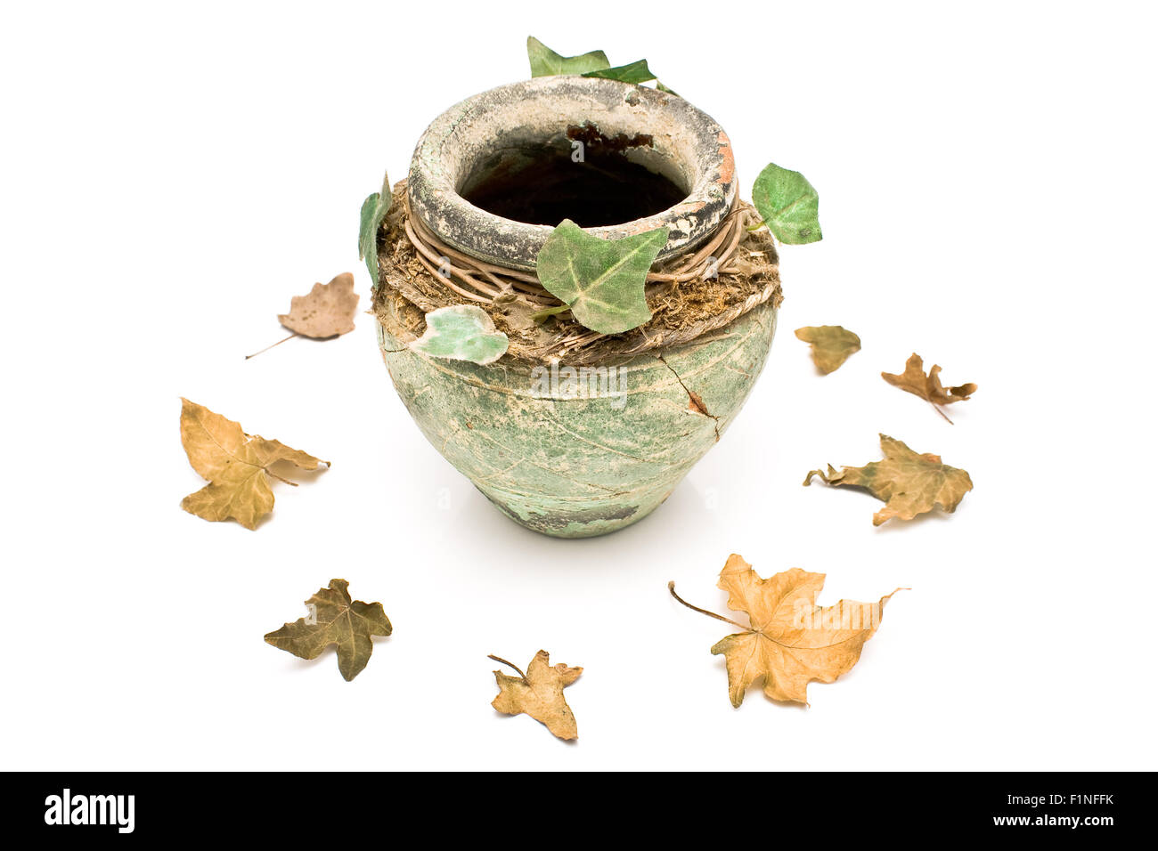 Old rustic clay pot with leaves isolated on white Stock Photo - Alamy