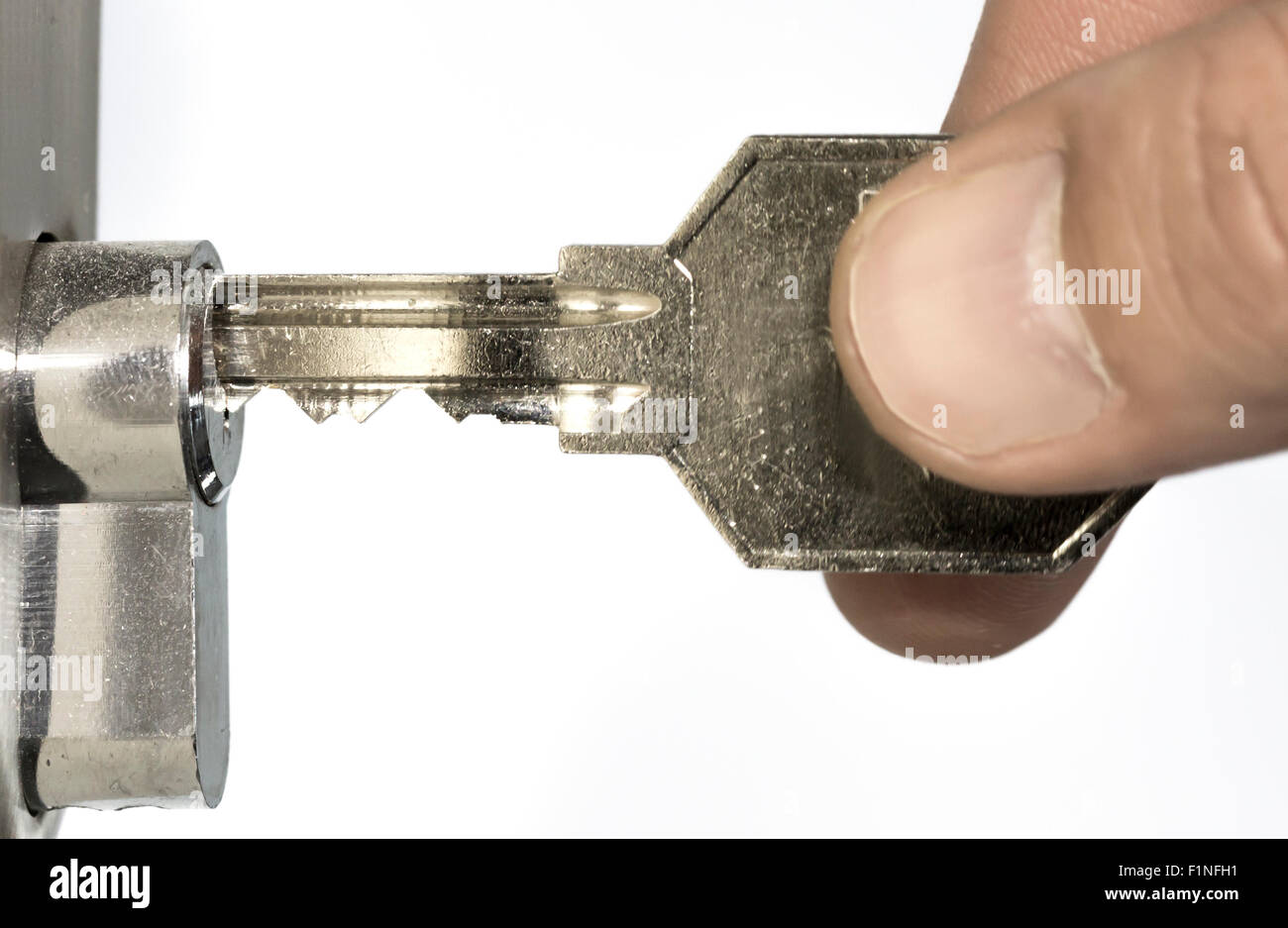 Human fingers inserting key into the door lock Stock Photo - Alamy
