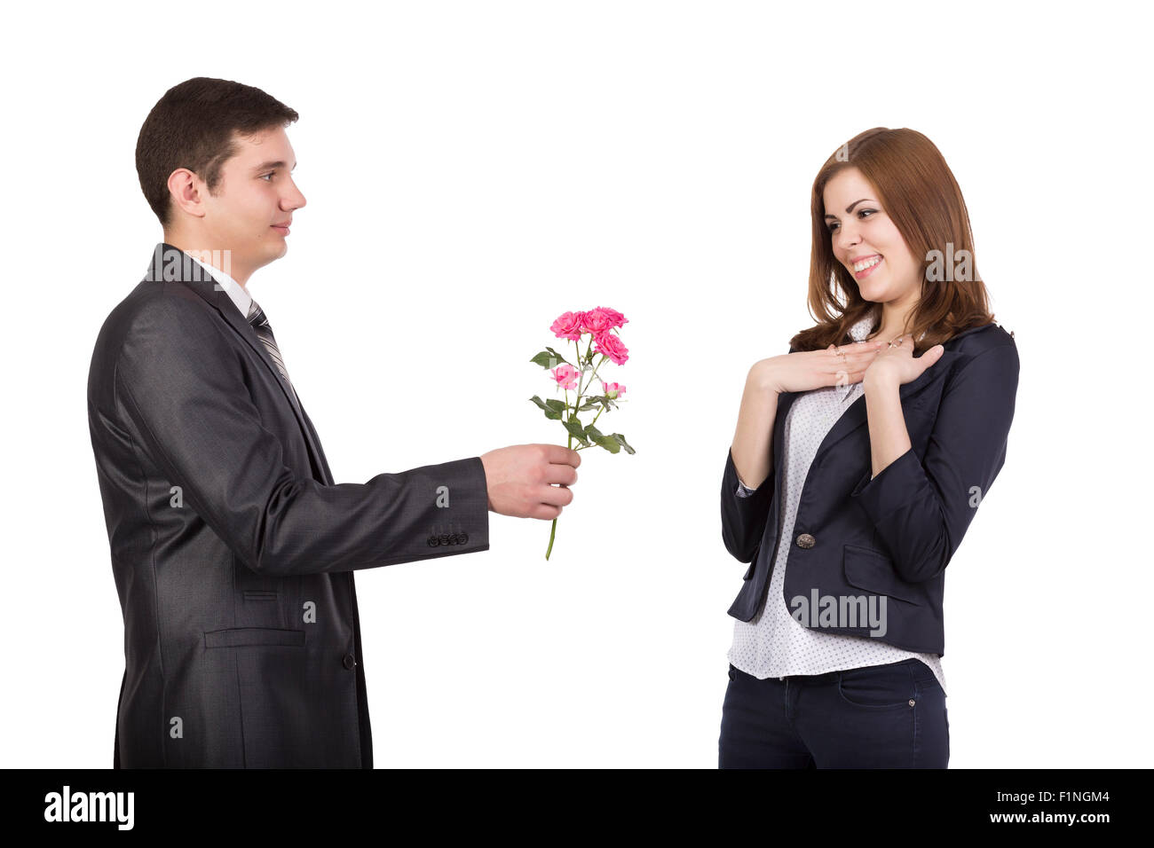 Young man gives a branch of flowers to beautiful lady Stock Photo - Alamy