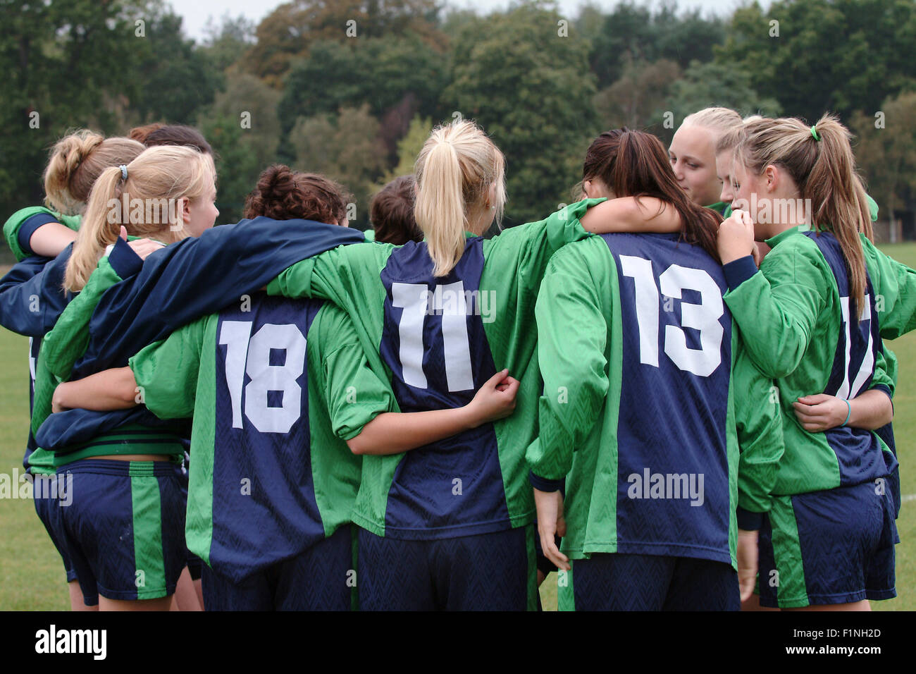Teenage female soccer players huddle before a game Stock Photo - Alamy