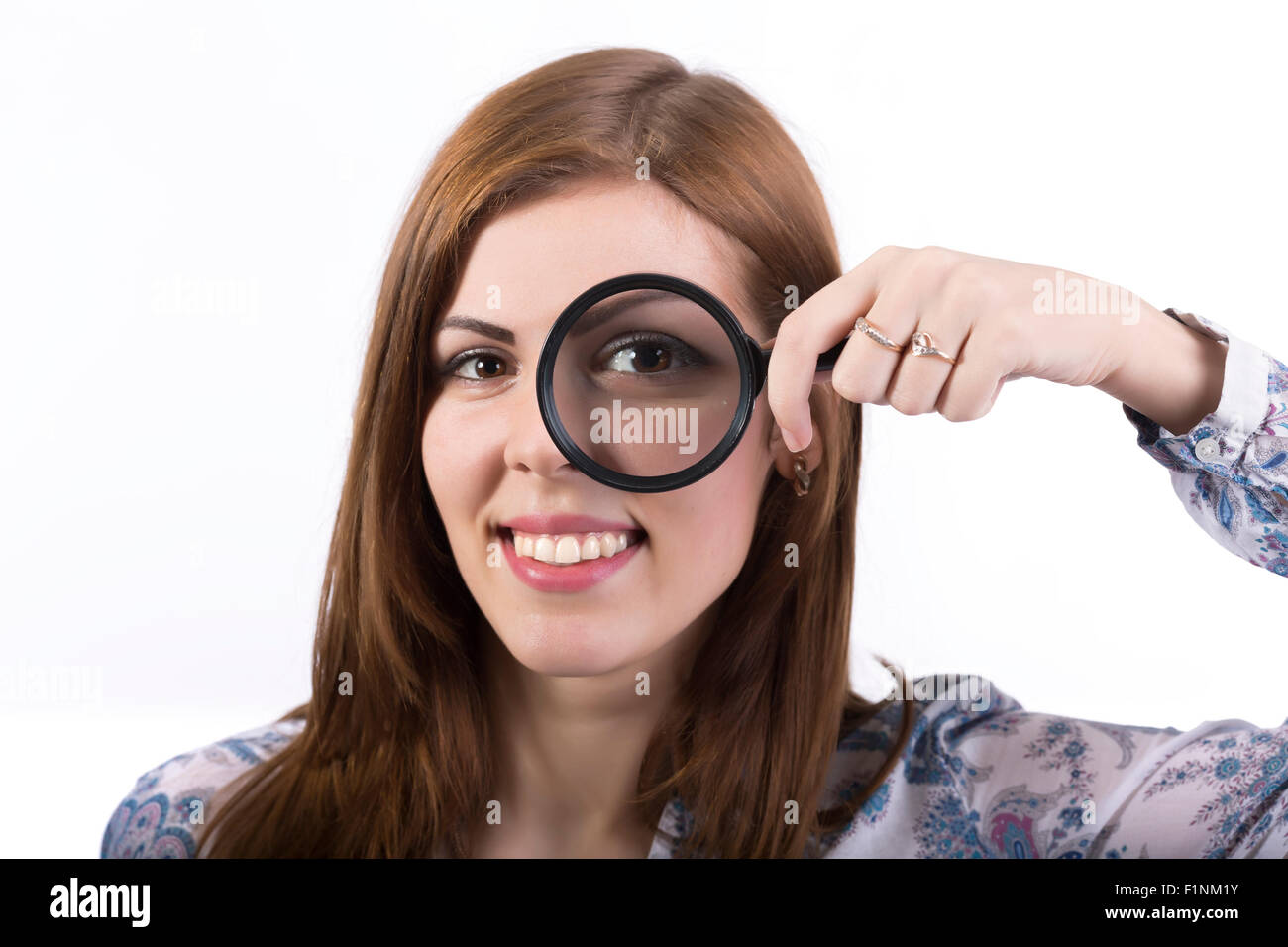 Female face looking through magnifier Stock Photo - Alamy
