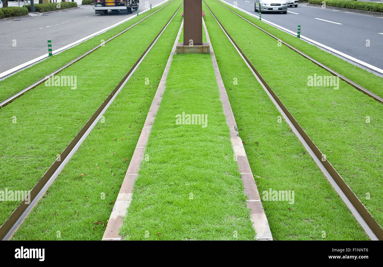 Tramway tracks on green lawn Stock Photo - Alamy