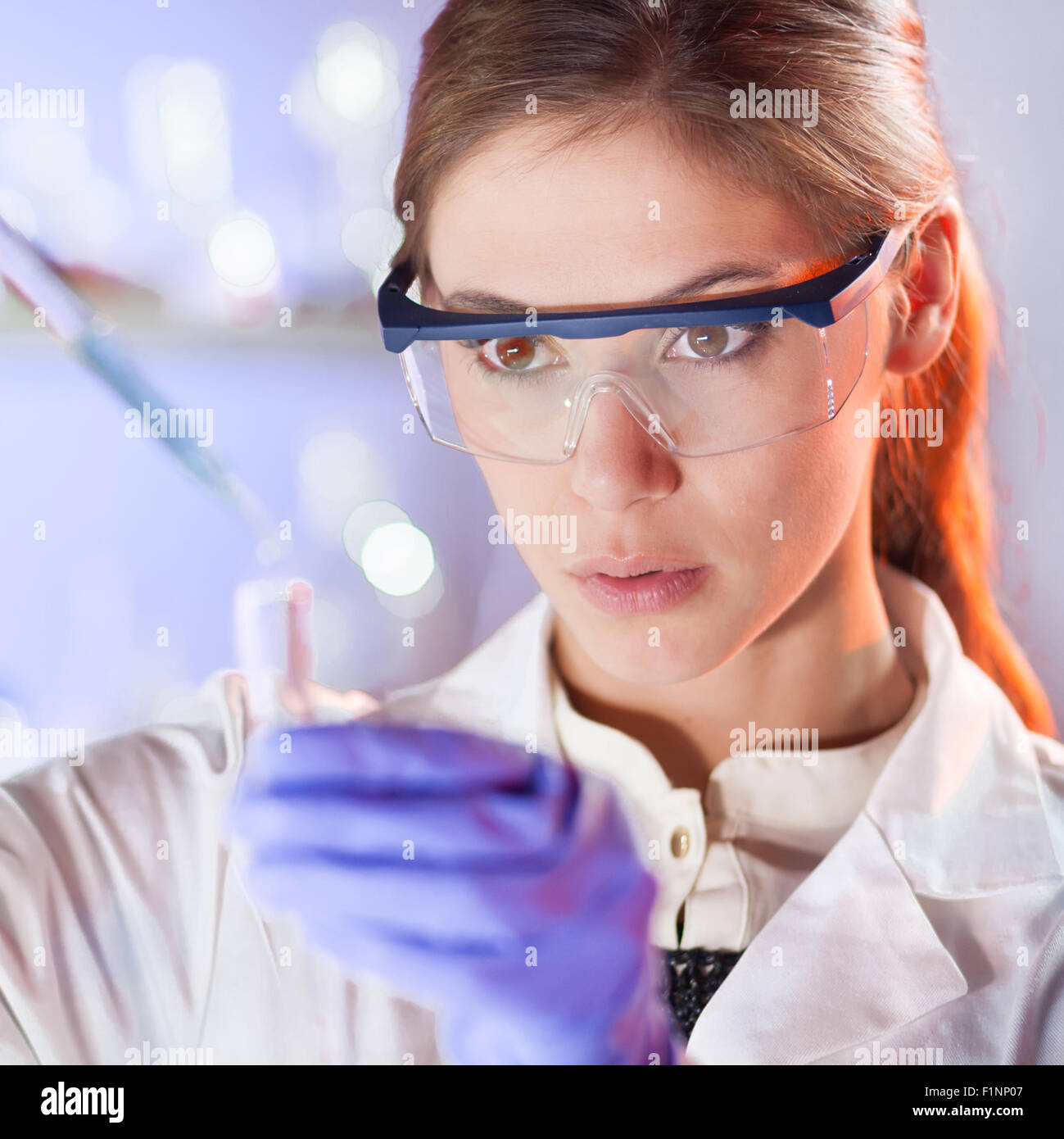 Young scientist pipetting in life science laboratory Stock Photo - Alamy
