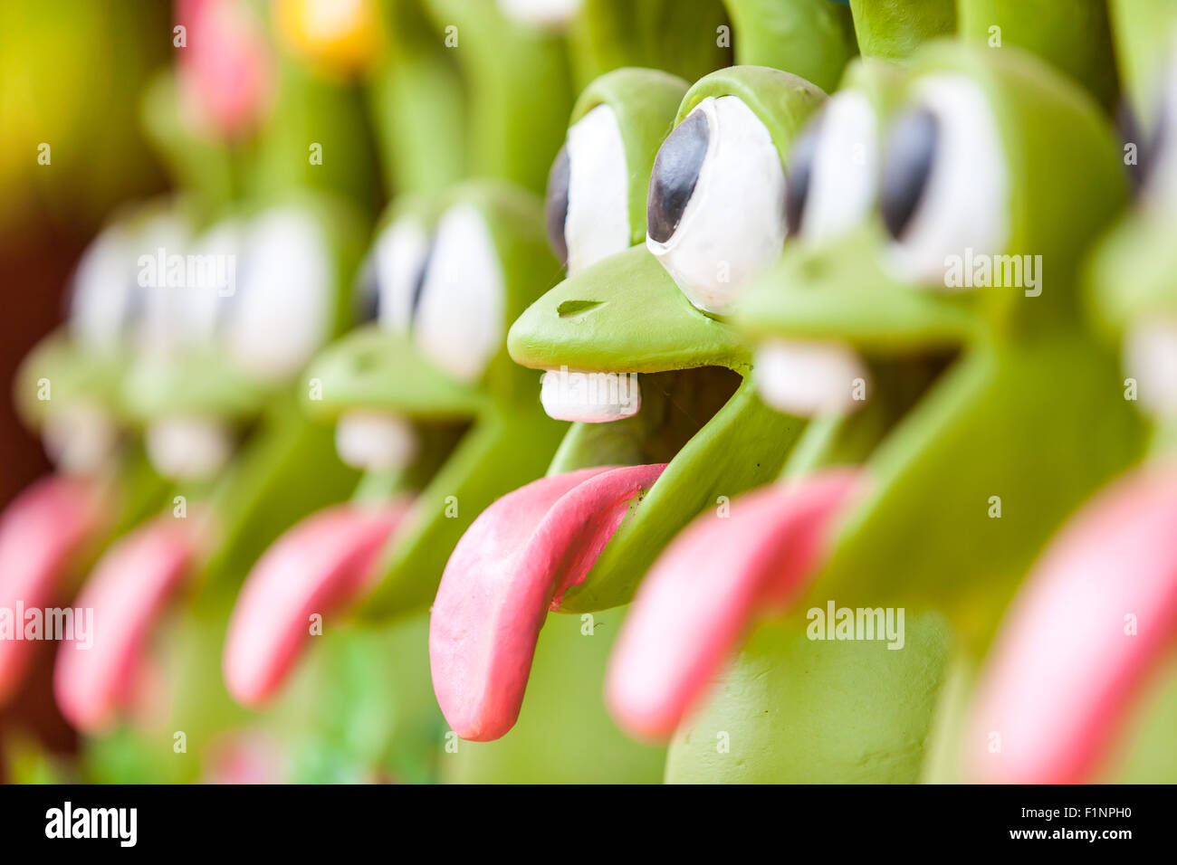 a few stone frogs with their tongues out Stock Photo - Alamy