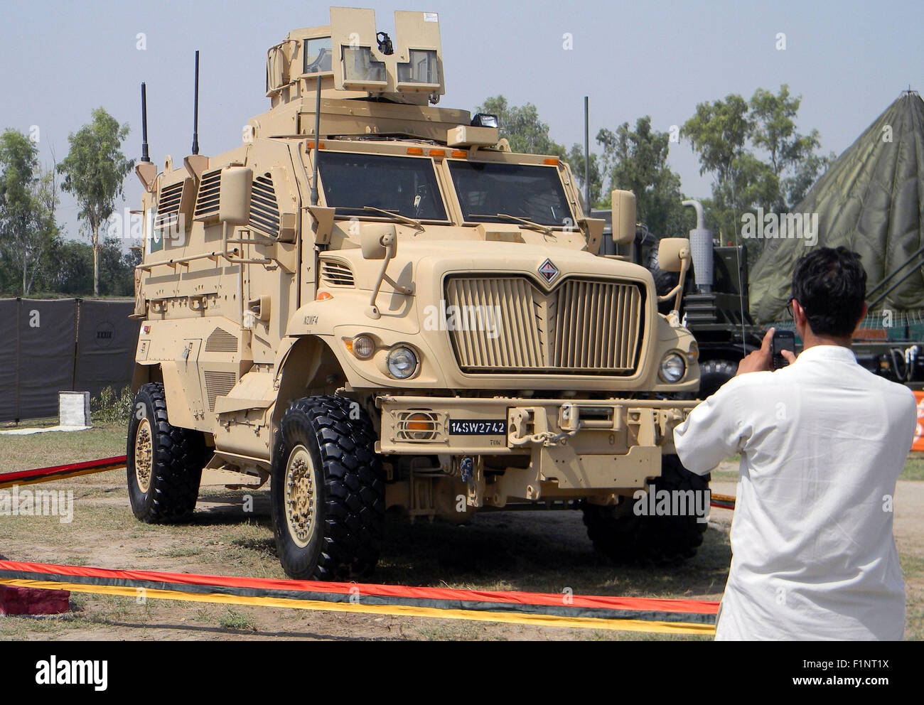 Peshawar. 5th Sep, 2015. A man takes photos of an armor truck ahead of ...