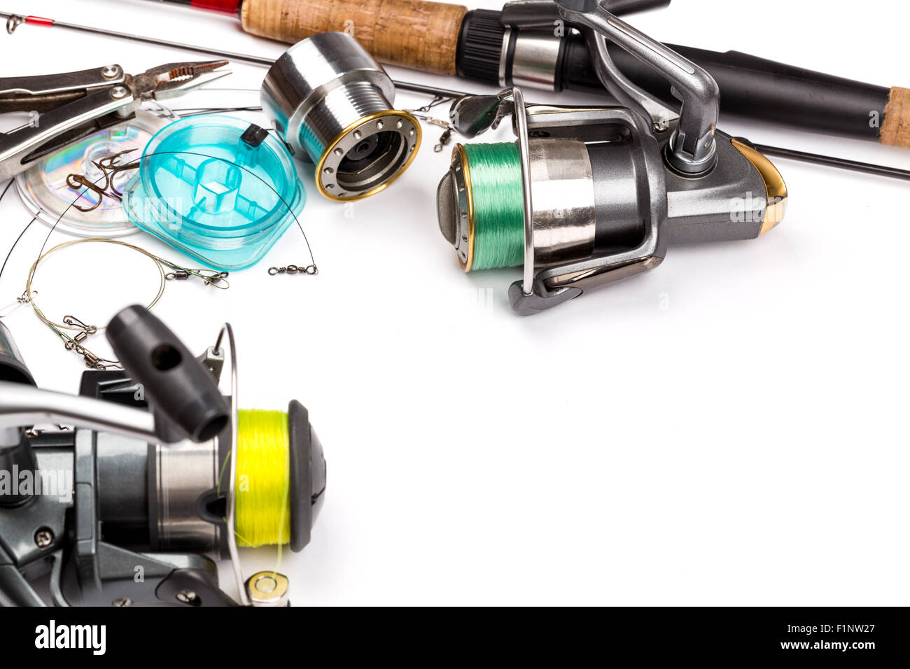 different fishing tackles - rod, reel, line and lures on white ...