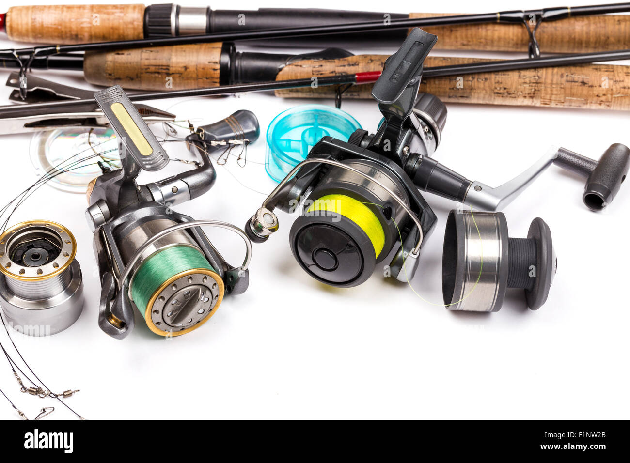 different fishing tackles - rod, reel, line and lures on white ...
