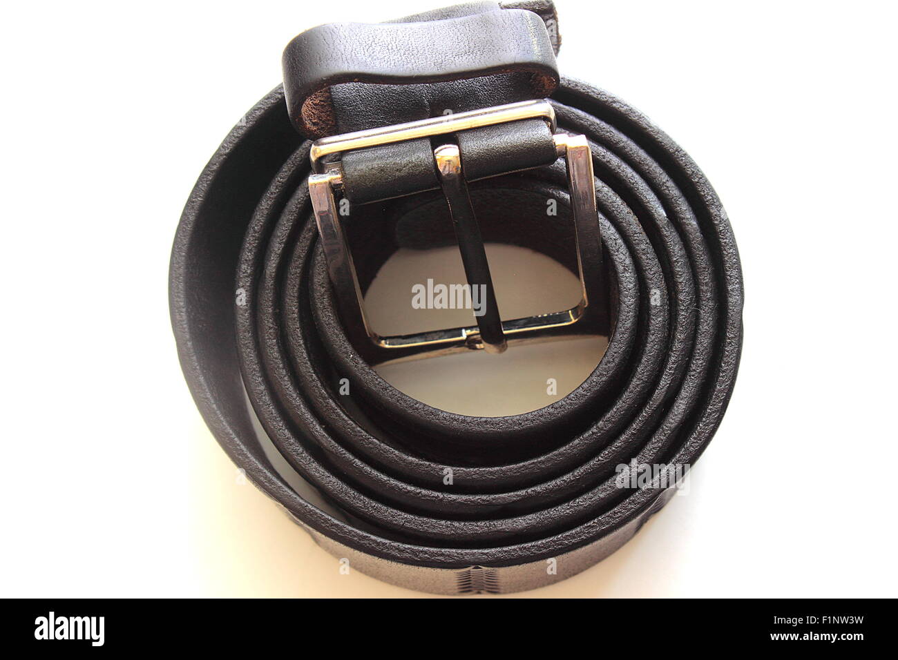 on a white background male black belt folded in a roll Stock Photo - Alamy