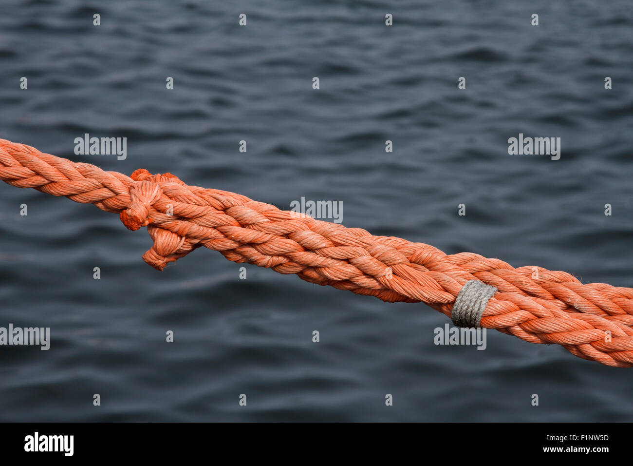Red rope against water surface Stock Photo - Alamy
