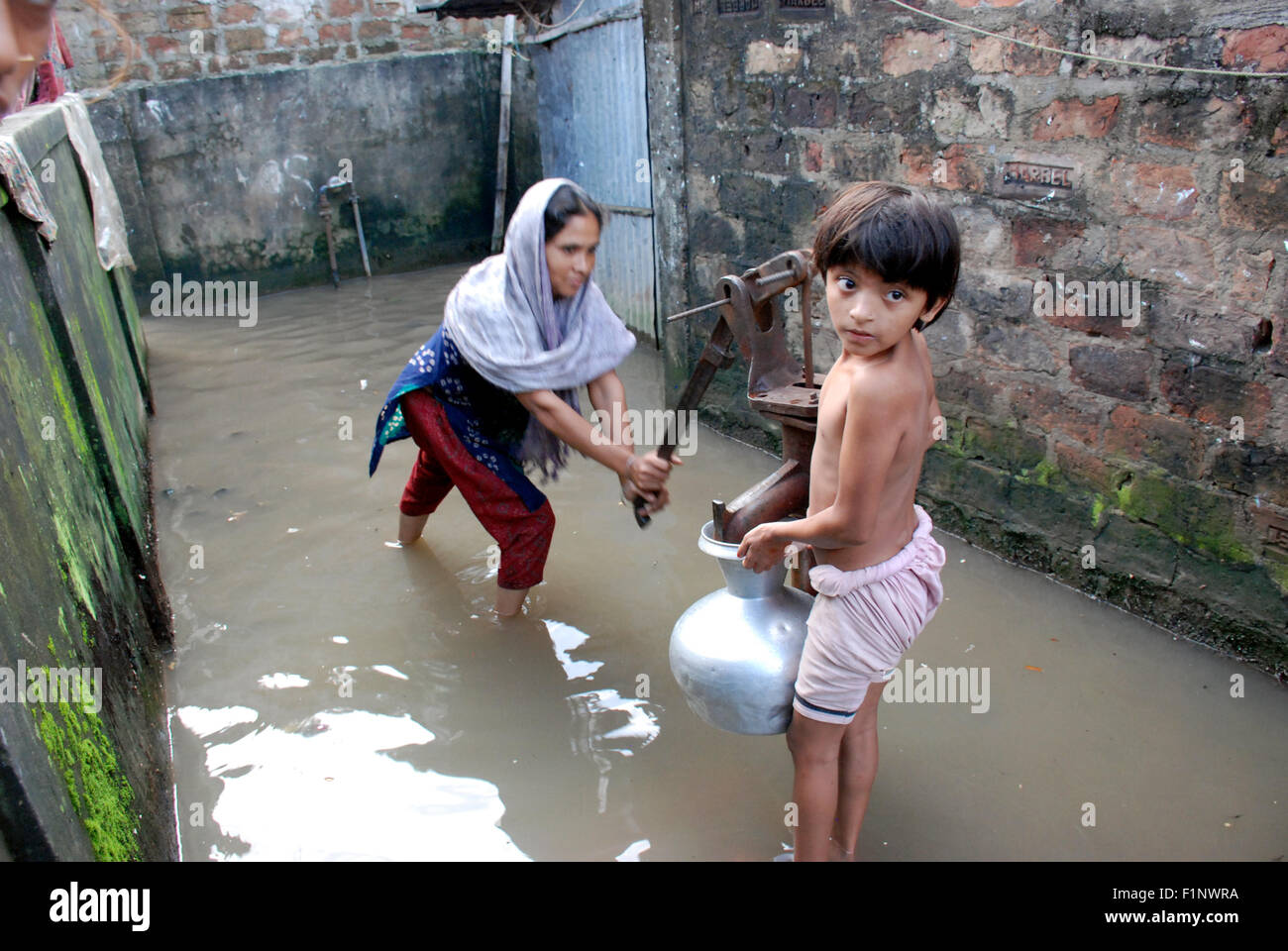 The flood-affected people collecting drinking water from tube-wells ...