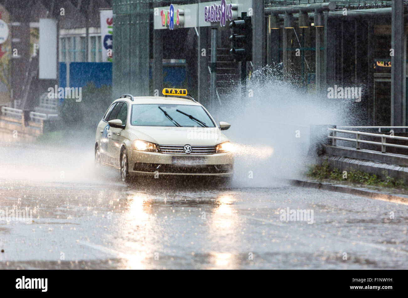 Cars driving in heavy rain weather, wet surface of the street ...