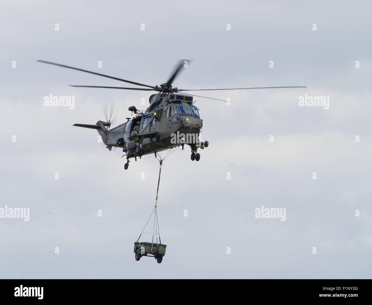 Military helicopter lifting a load in support of troops Stock Photo - Alamy