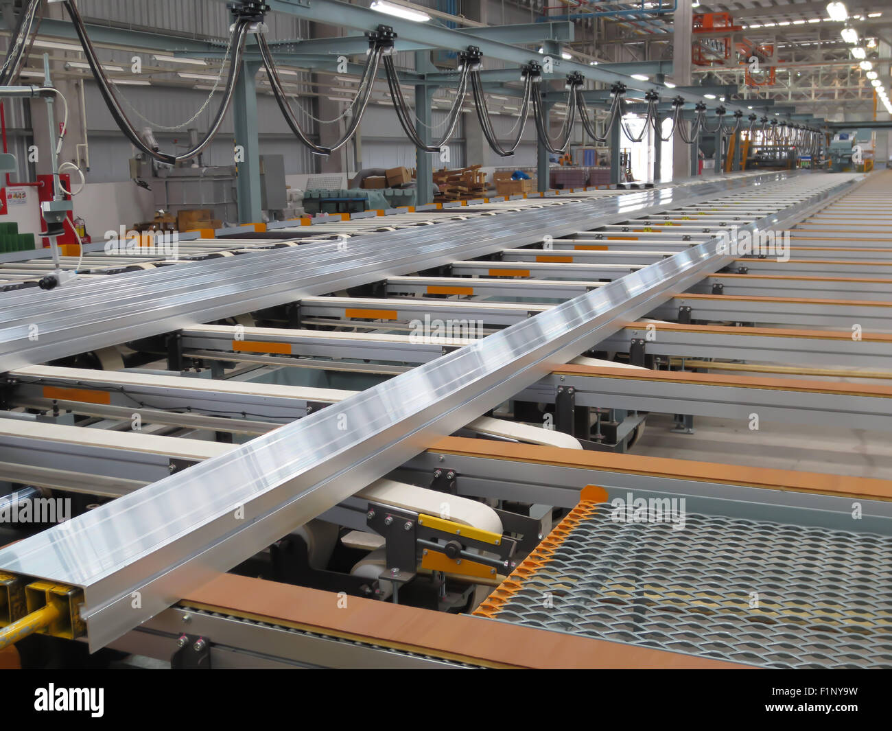 Aluminum lines on a conveyor belt in a factory Stock Photo - Alamy
