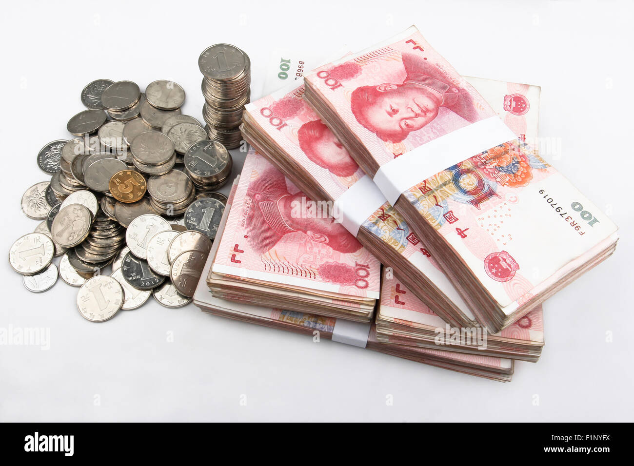 Stacked Chinese 100 notes with coins in the left side Stock Photo - Alamy