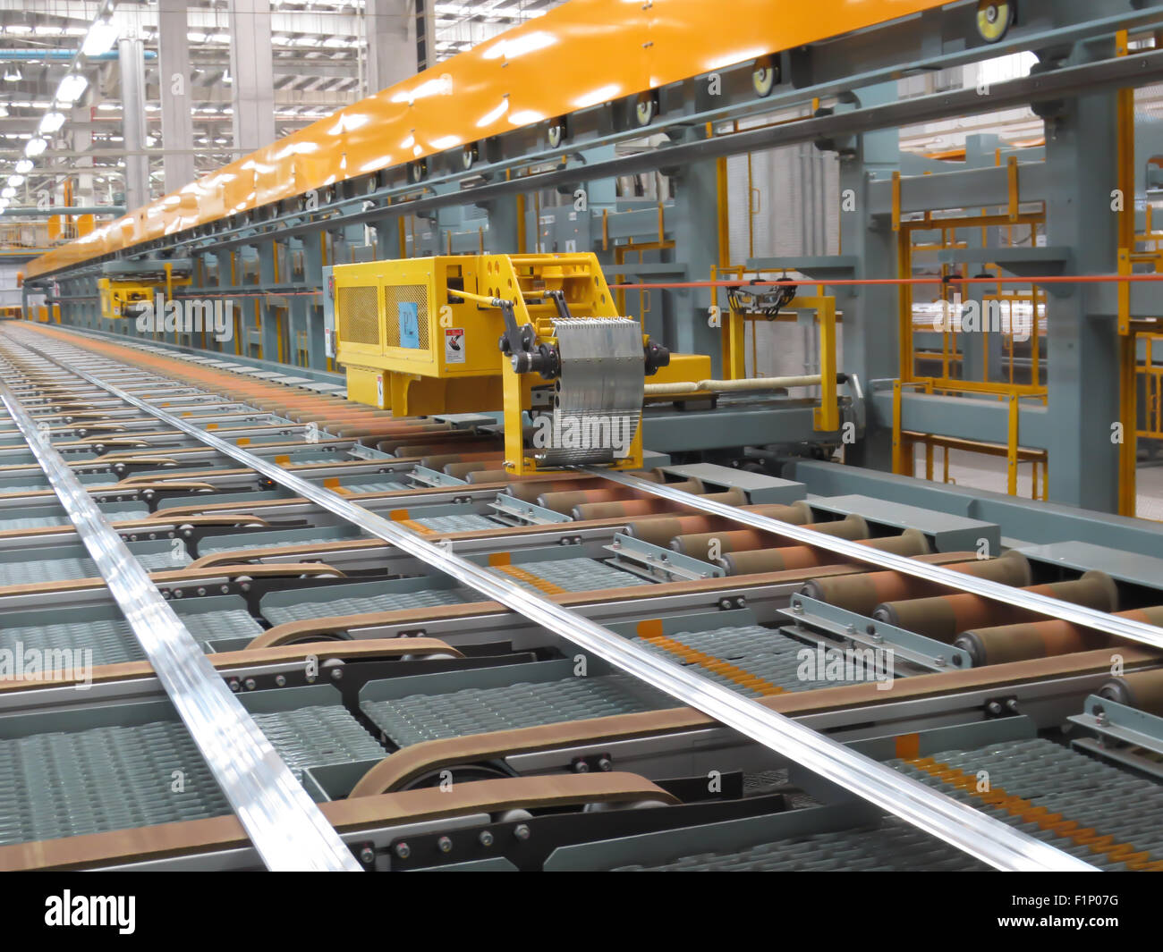 Aluminum lines on a conveyor belt in a factory Stock Photo - Alamy