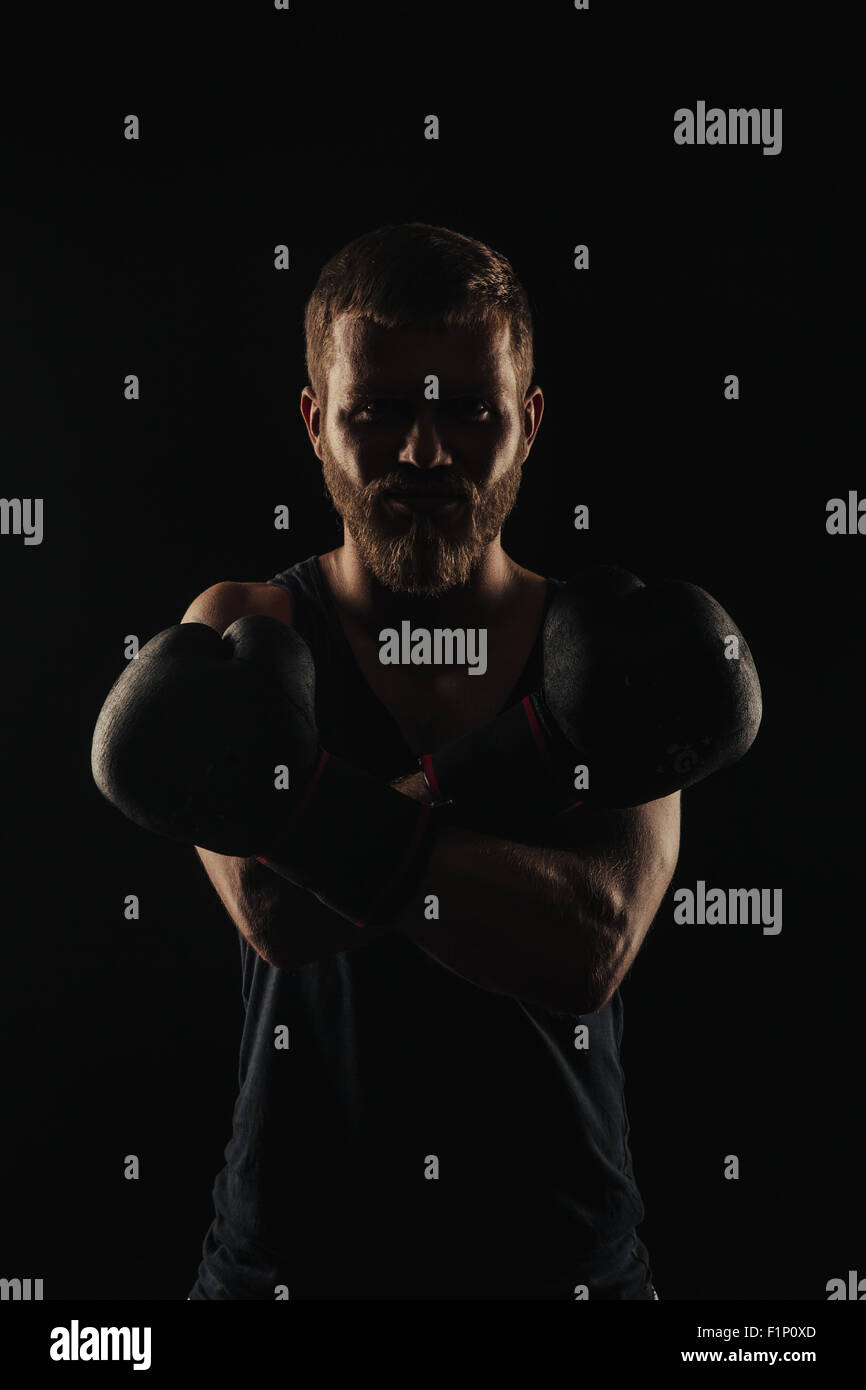 Athletic bearded boxer with gloves on a dark background Stock Photo - Alamy