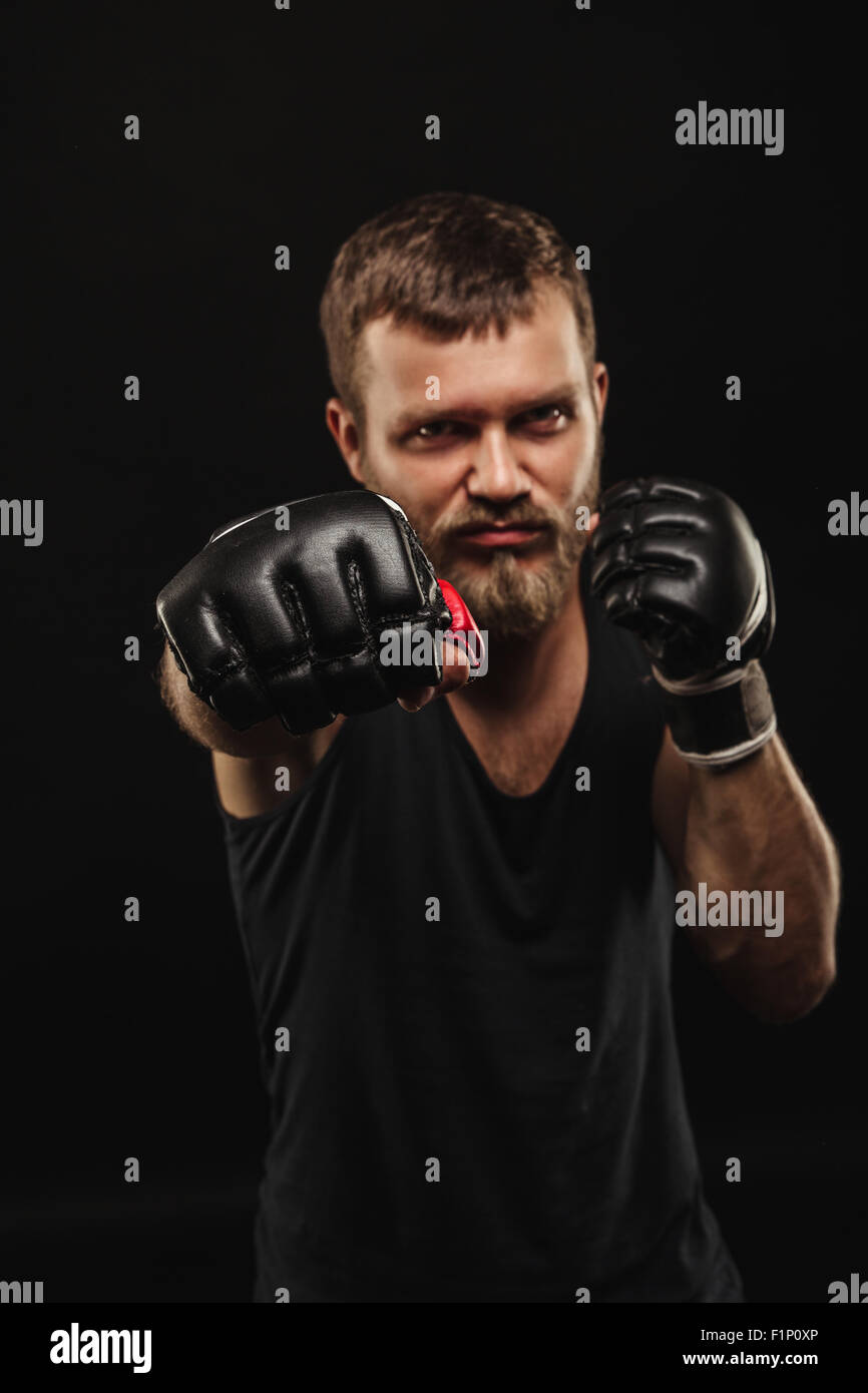 Athletic bearded boxer with gloves on a dark background Stock Photo - Alamy