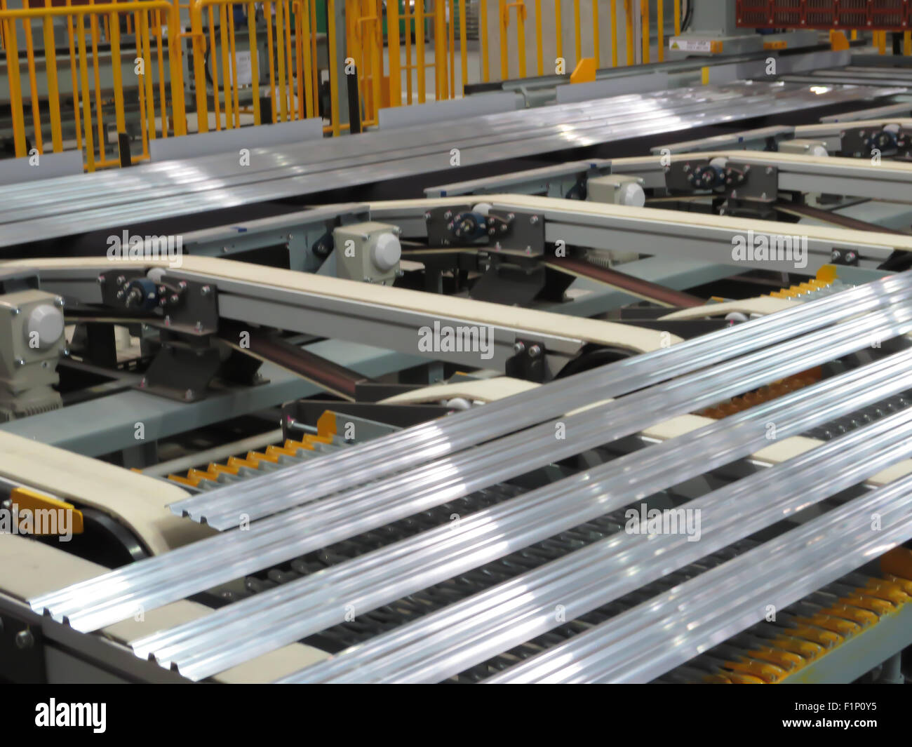 Aluminum lines on a conveyor belt in a factory Stock Photo - Alamy