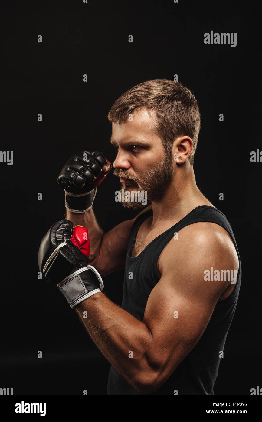 Athletic bearded boxer with gloves on a dark background Stock Photo - Alamy